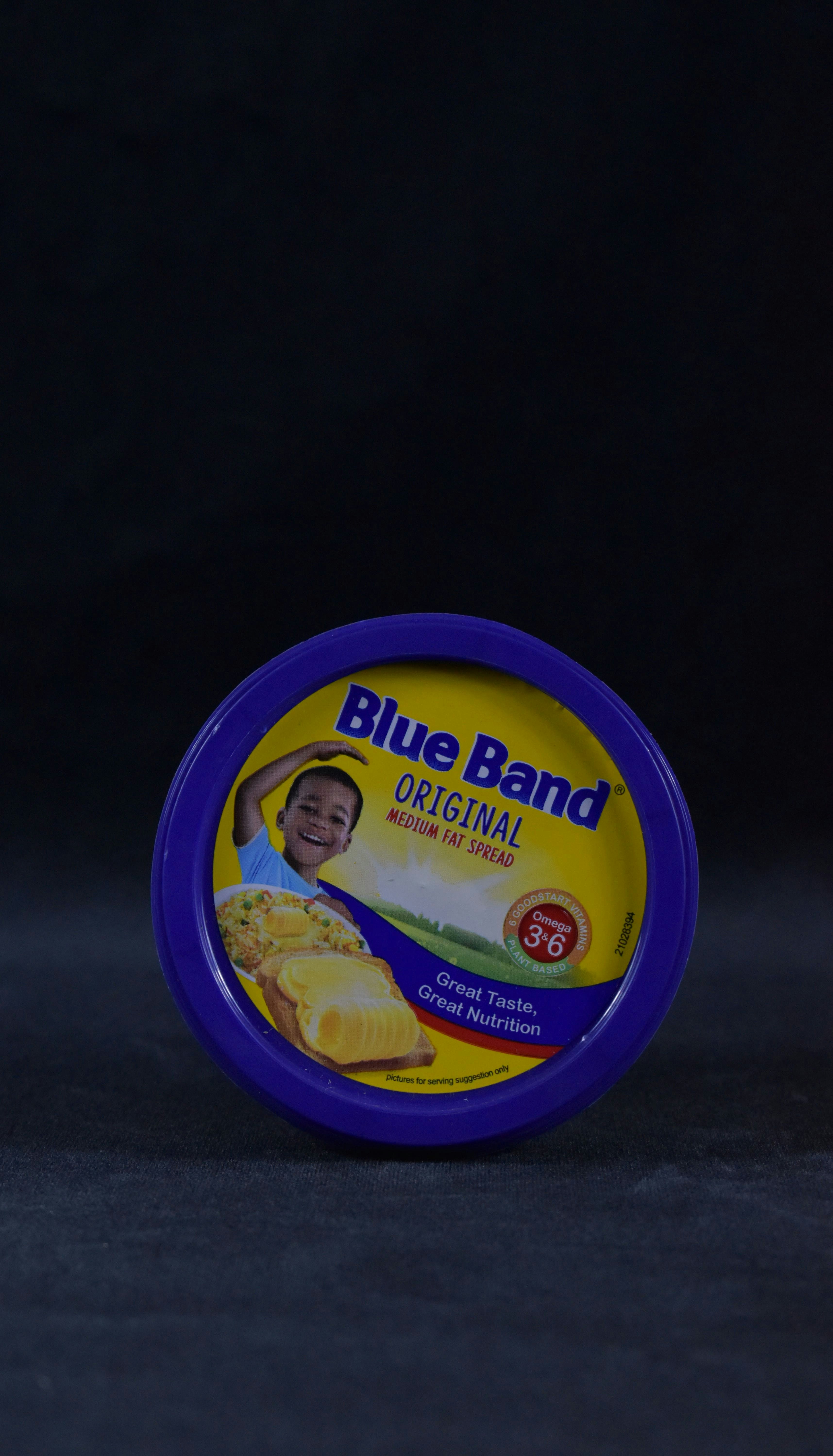 A blue band container sitting on a table photo – Free Food Image on ...