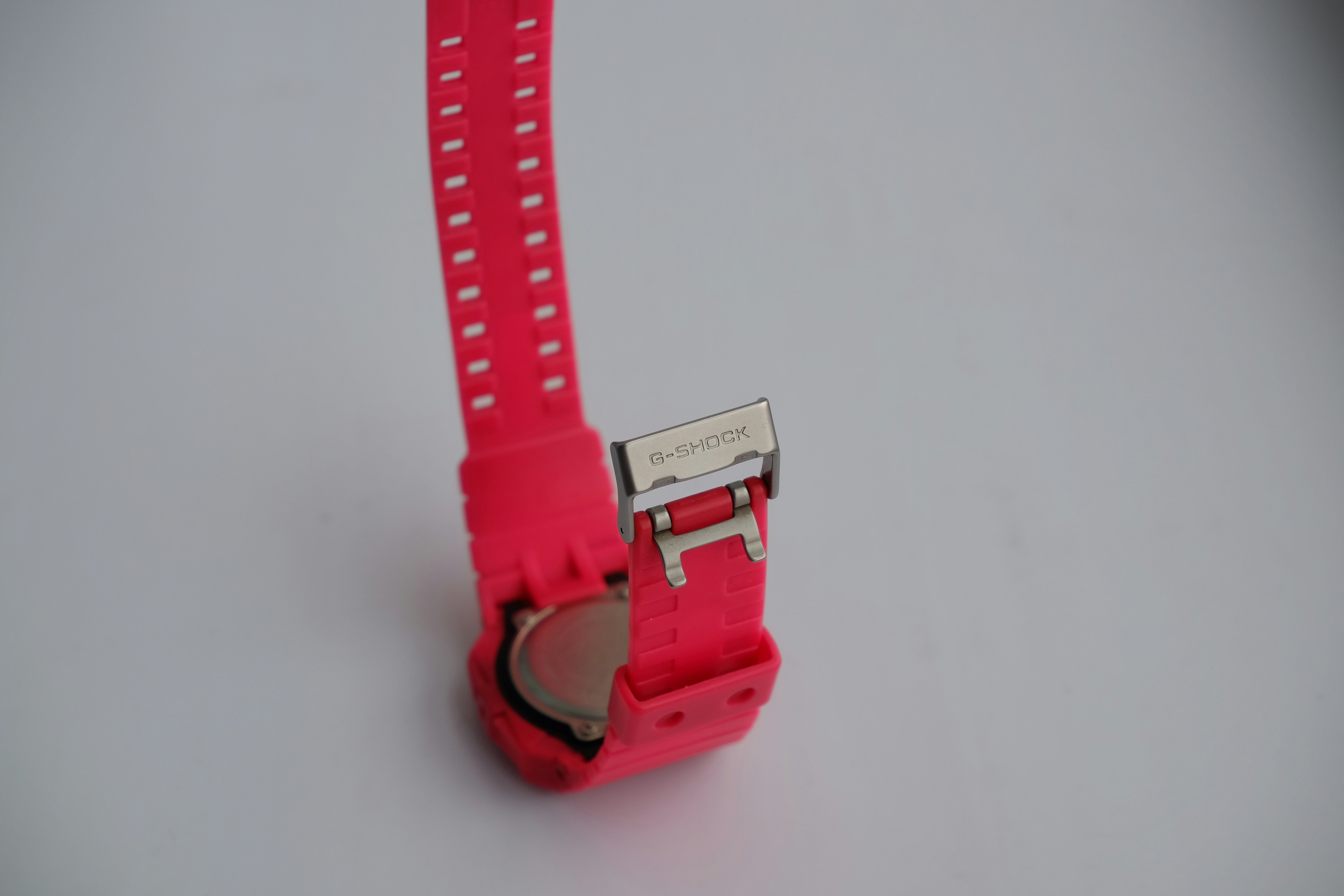 Crimson G-Shock Strap Buckle: Minimalist Studio Close-Up