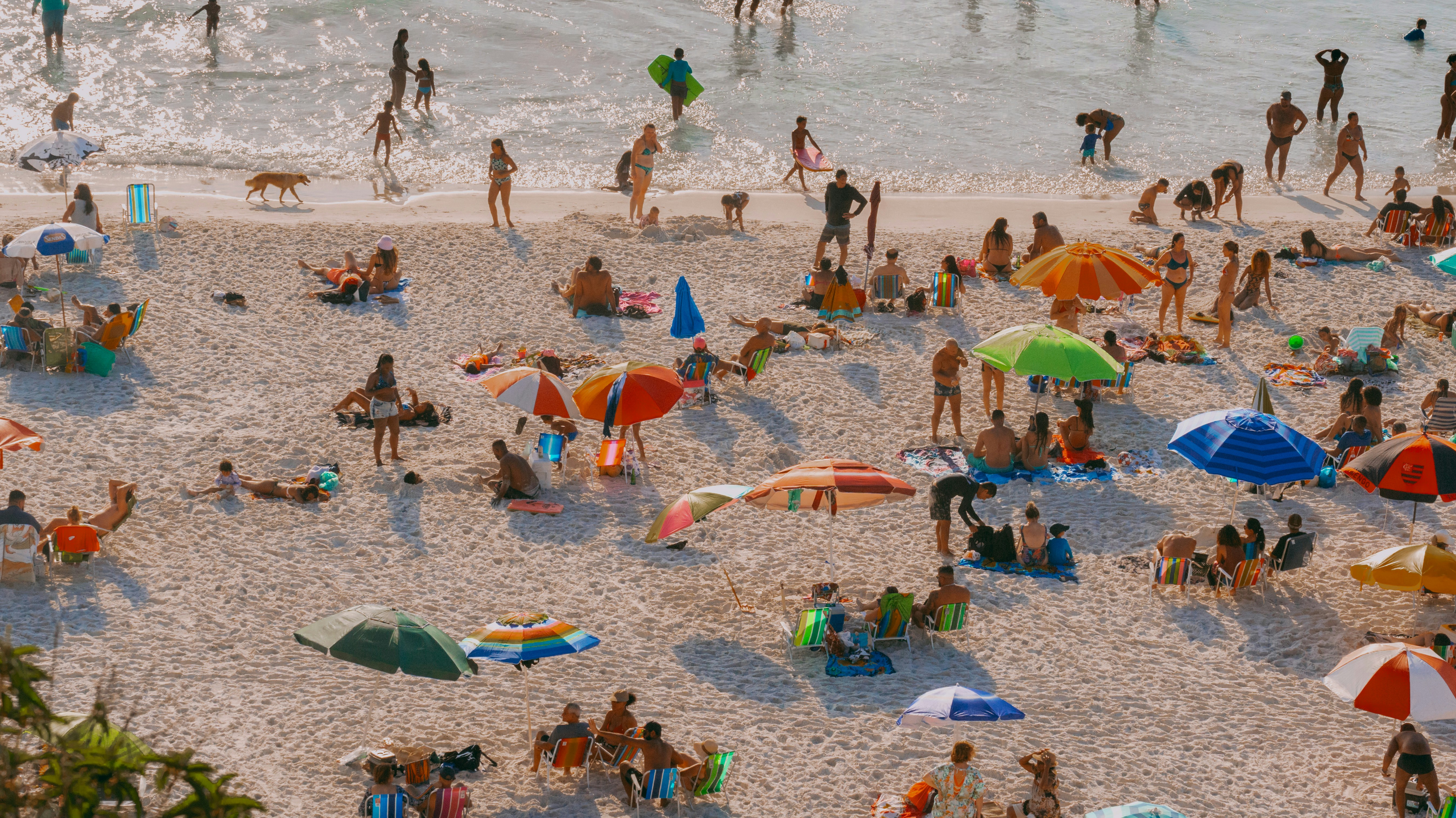 A crowded beach with many people and umbrellas photo – Free Sea Image ...