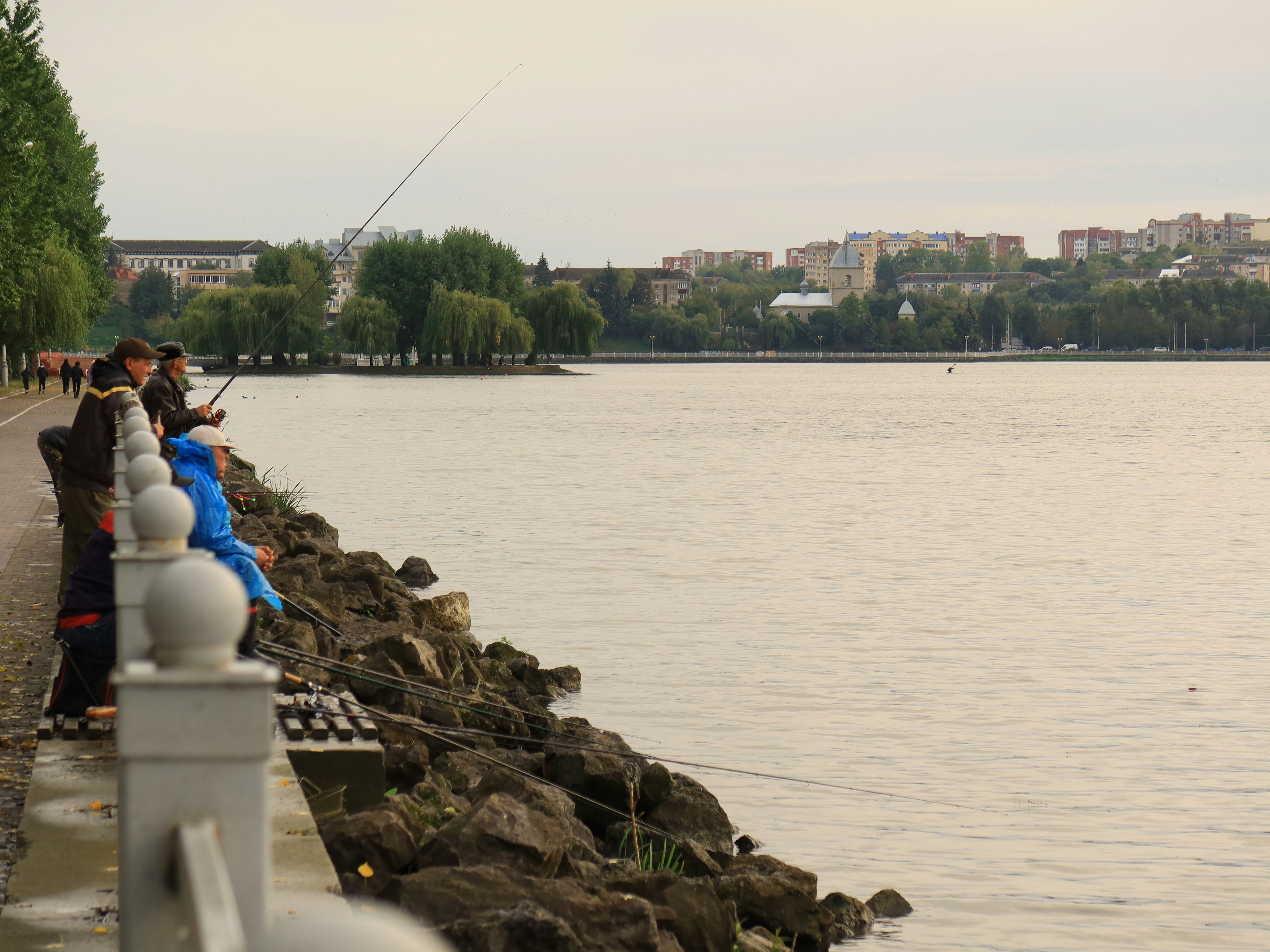 Lined by the River: Anglers in a Coastal Urban Walk