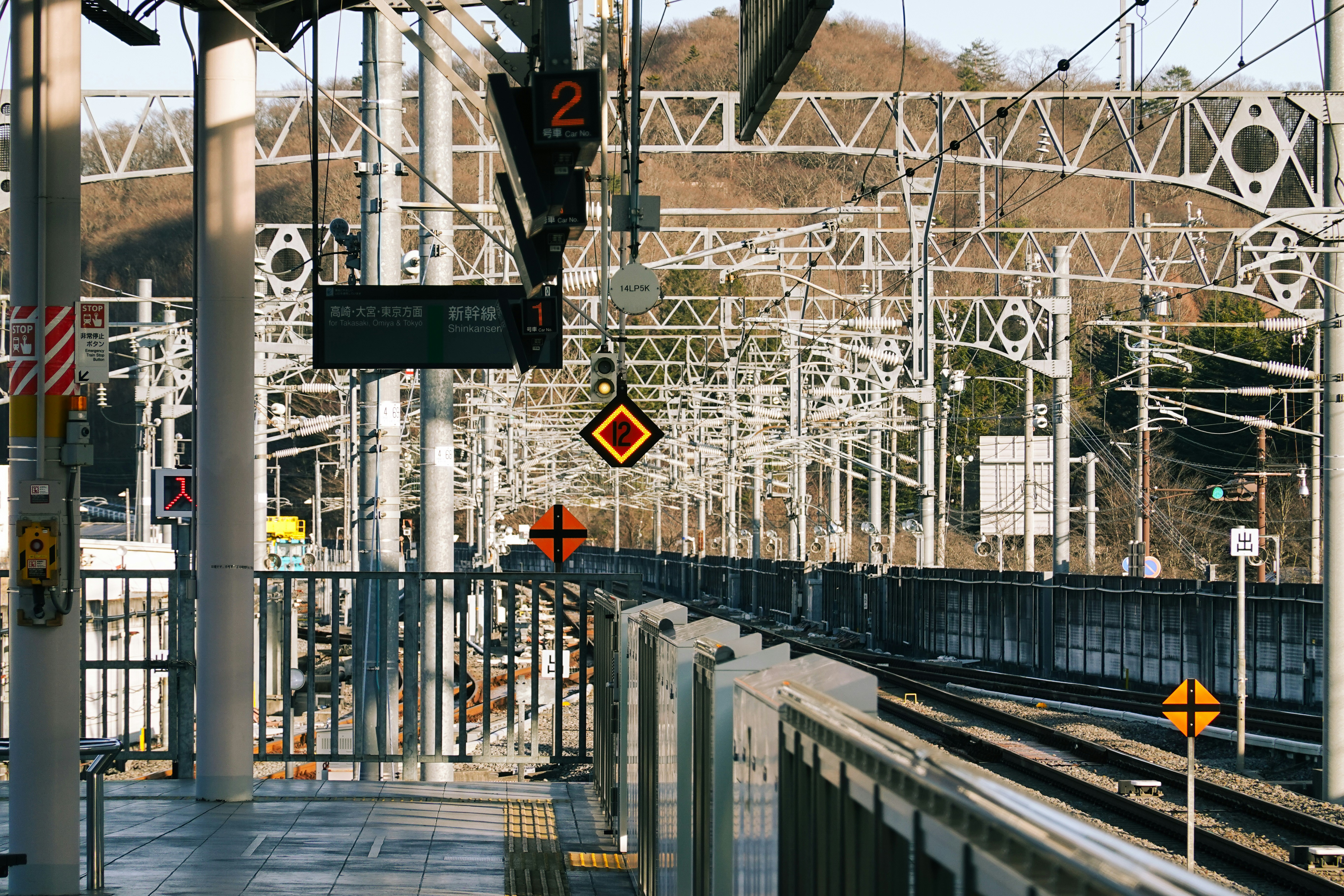 A train traveling down train tracks next to a train station photo ...