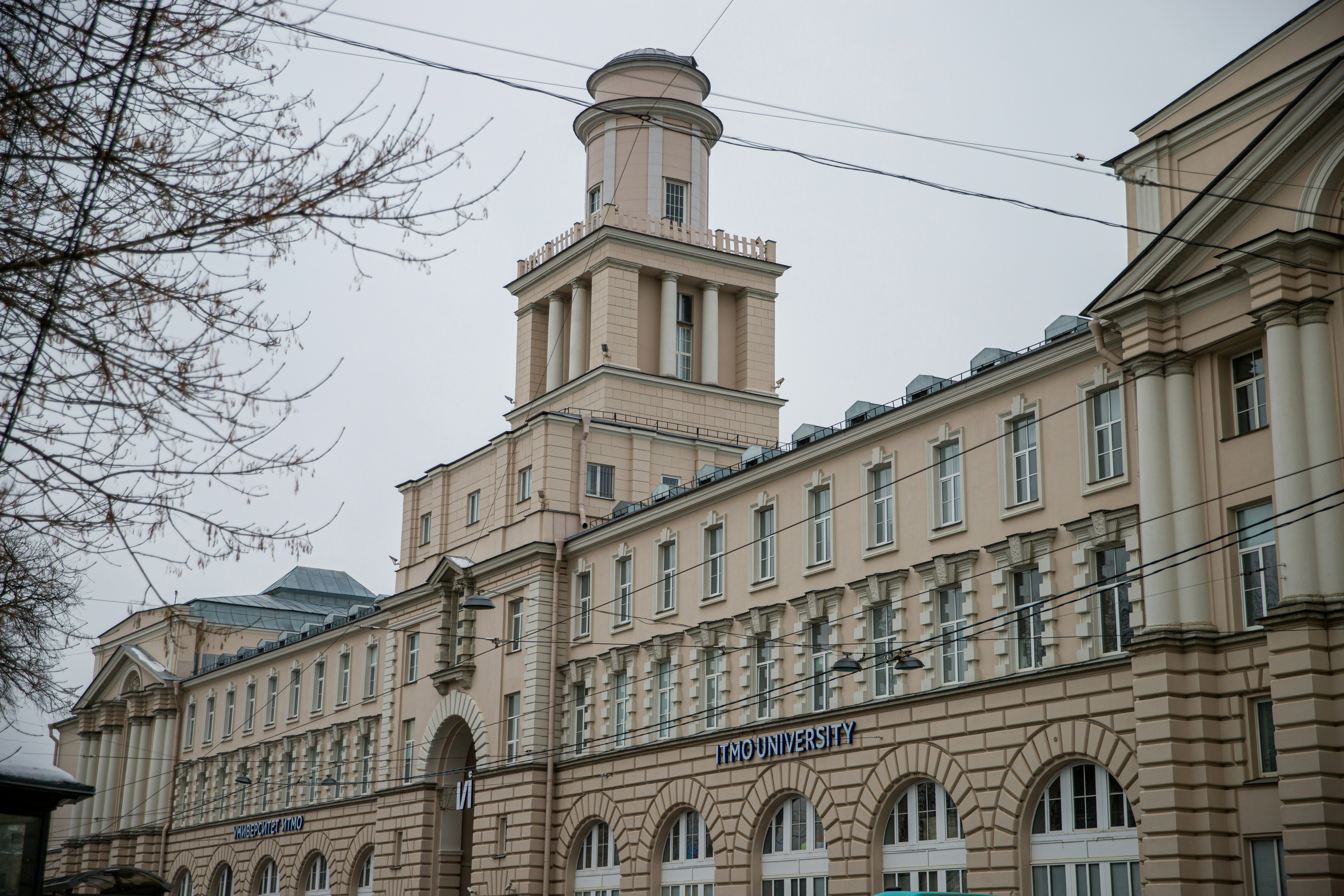 Towering Campus Clocktower: A Historic University Facade under Cloudy Light