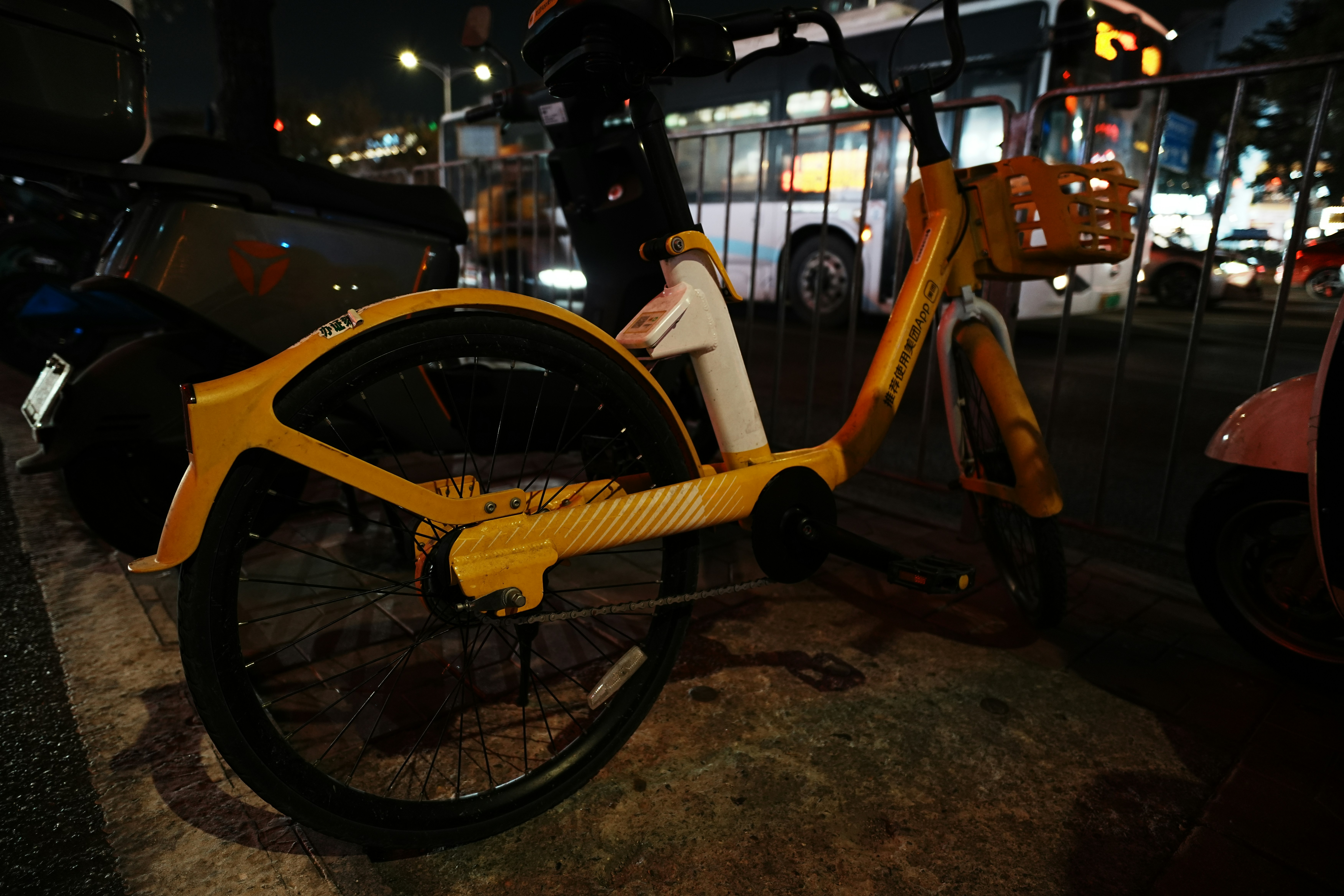A yellow bicycle parked on the side of the road photo – Free Car Image ...