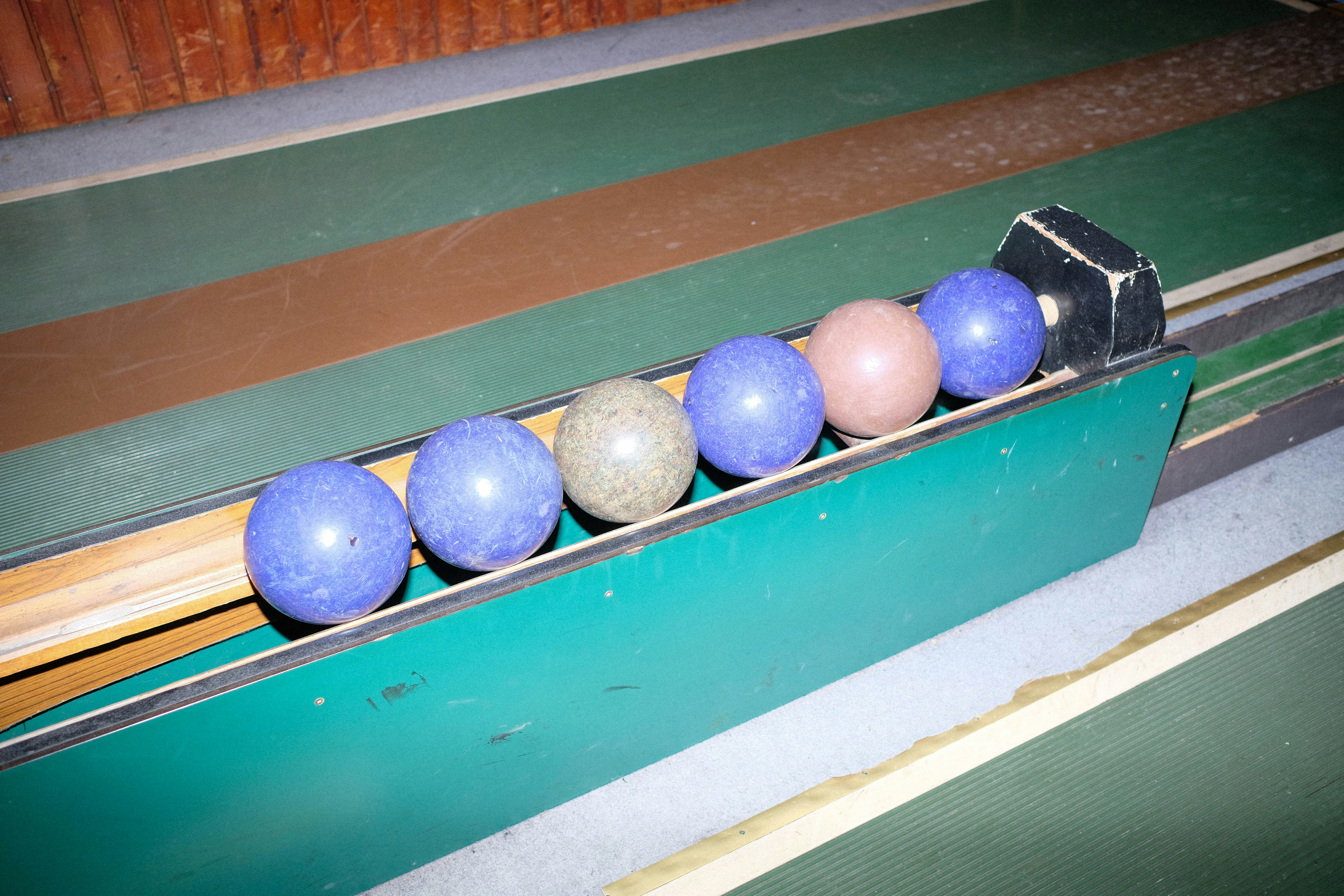 A row of bowling balls in a bowling alley photo – Free Skateboard Image ...