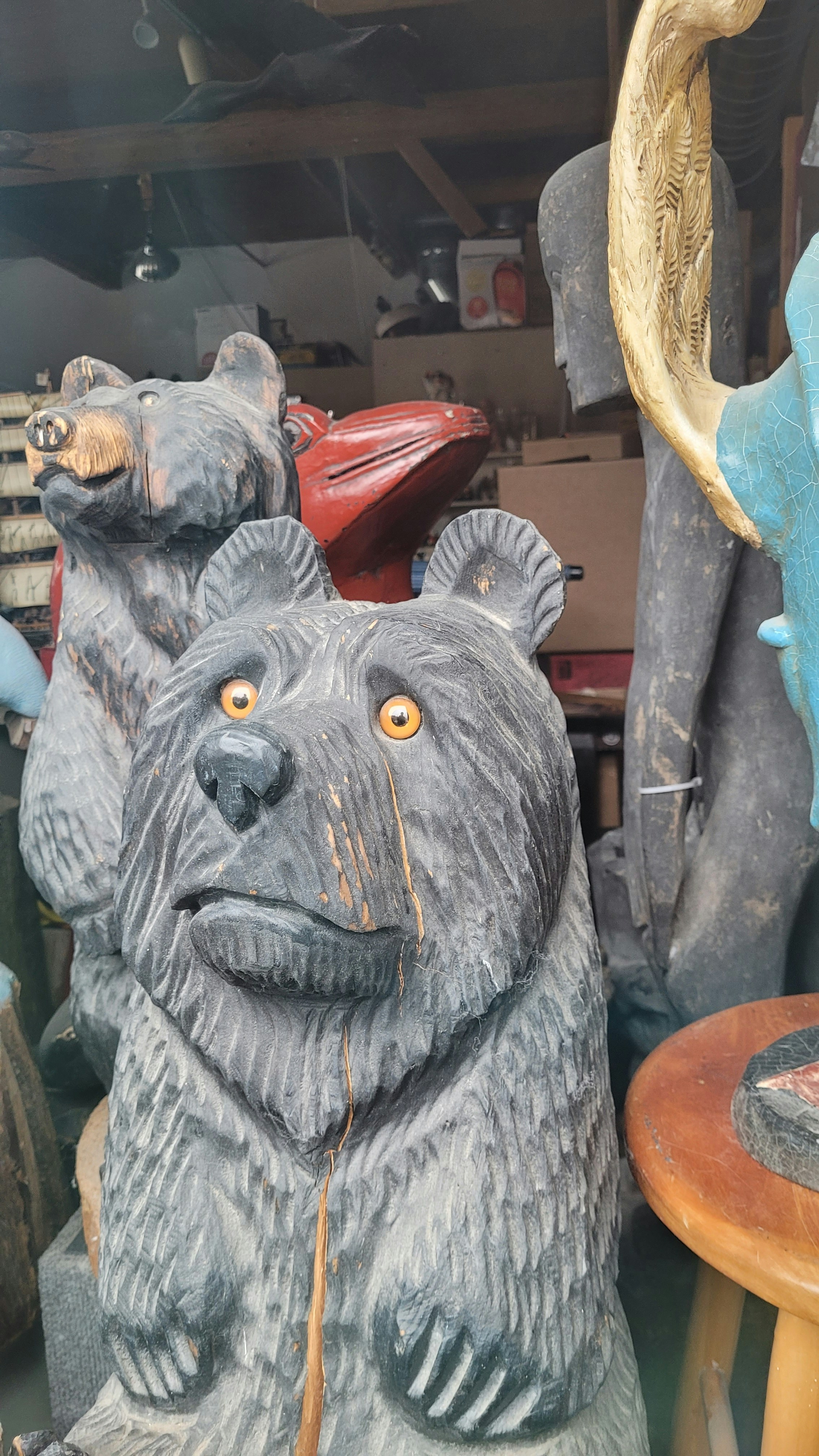 Wooden bear sculptures in an antique shop.