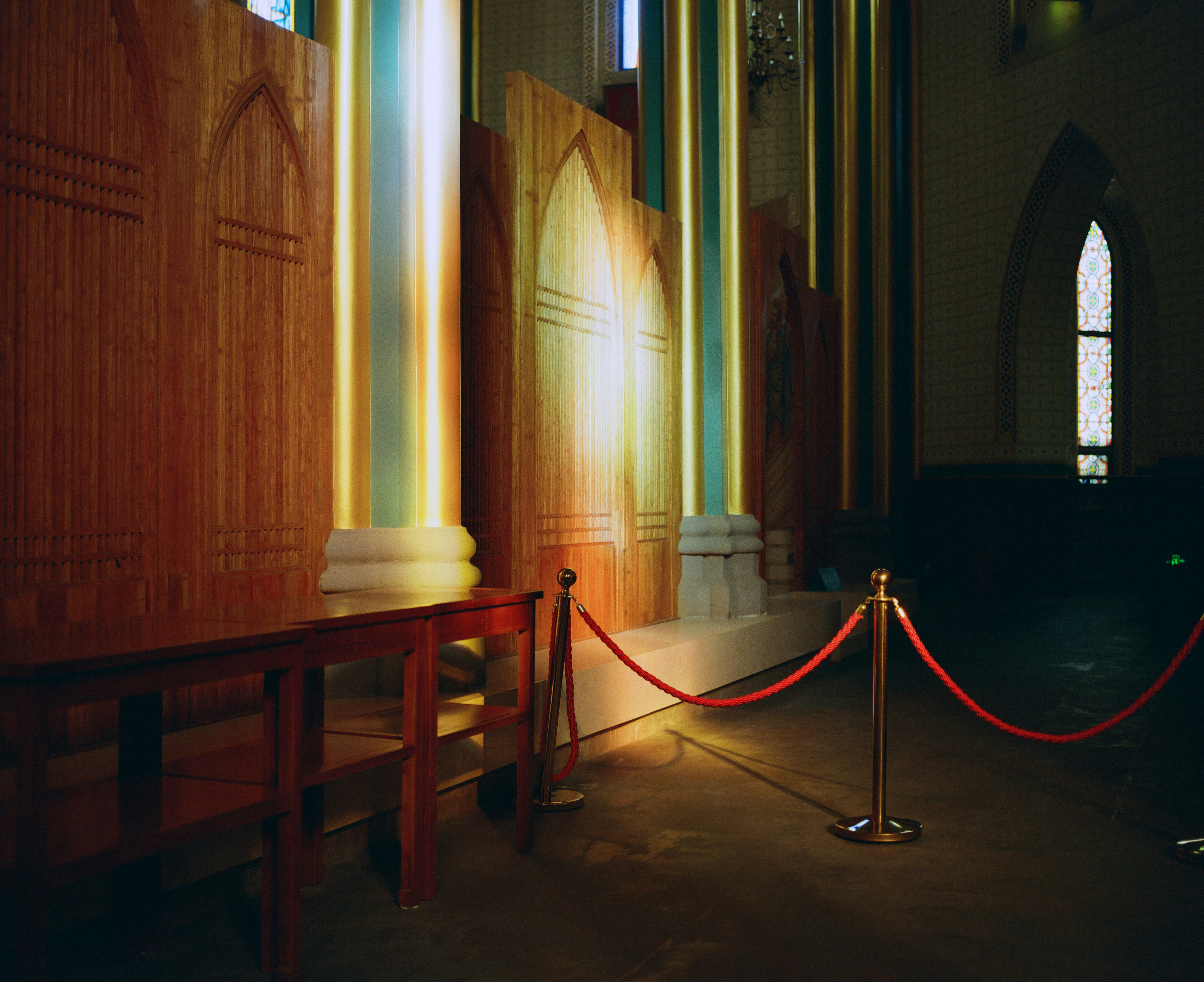 A room with a red carpet and a red rope photo – Free Crypt Image on ...