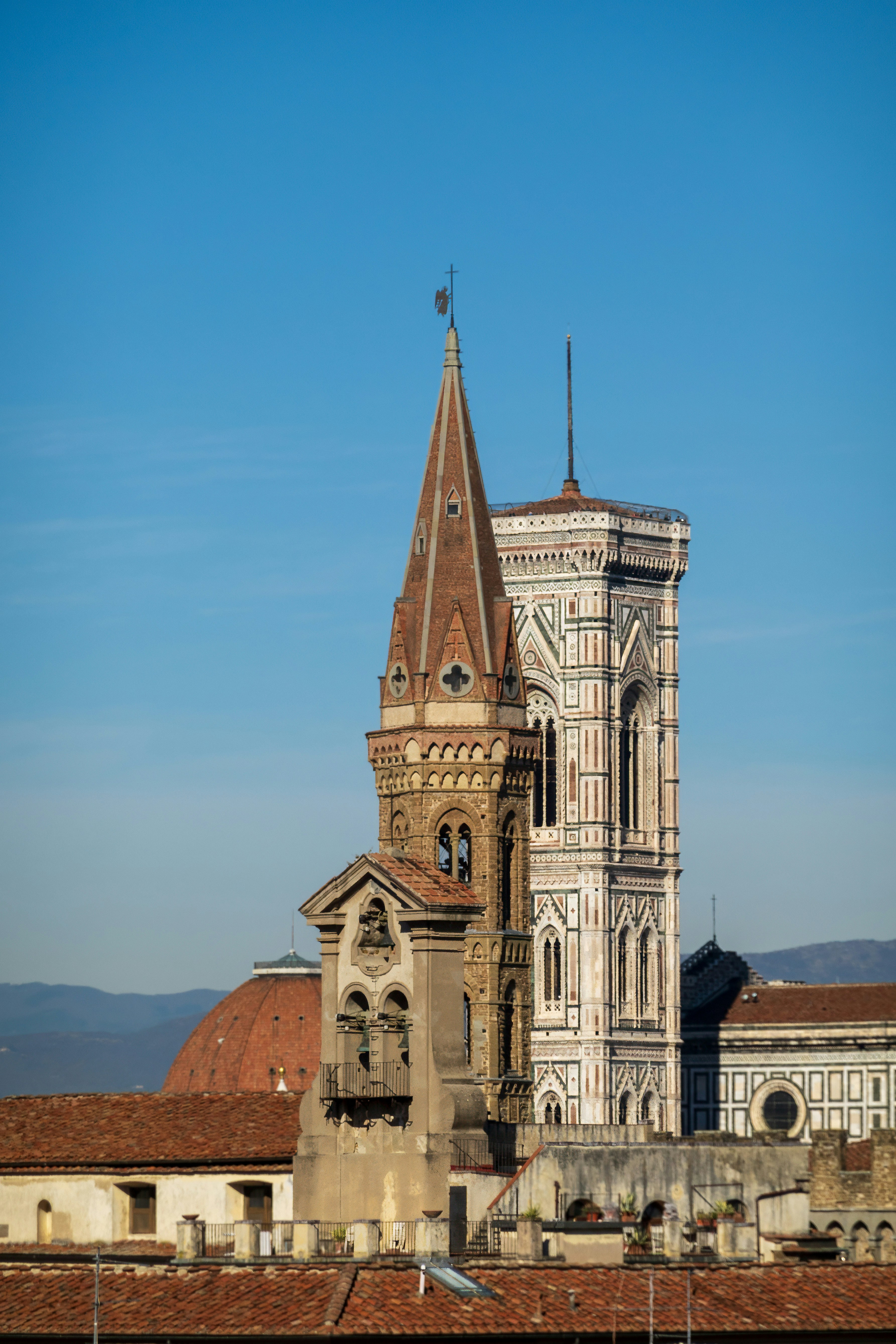 Spire Against Stripes: Florence’s Duomo Towers in Morning Light