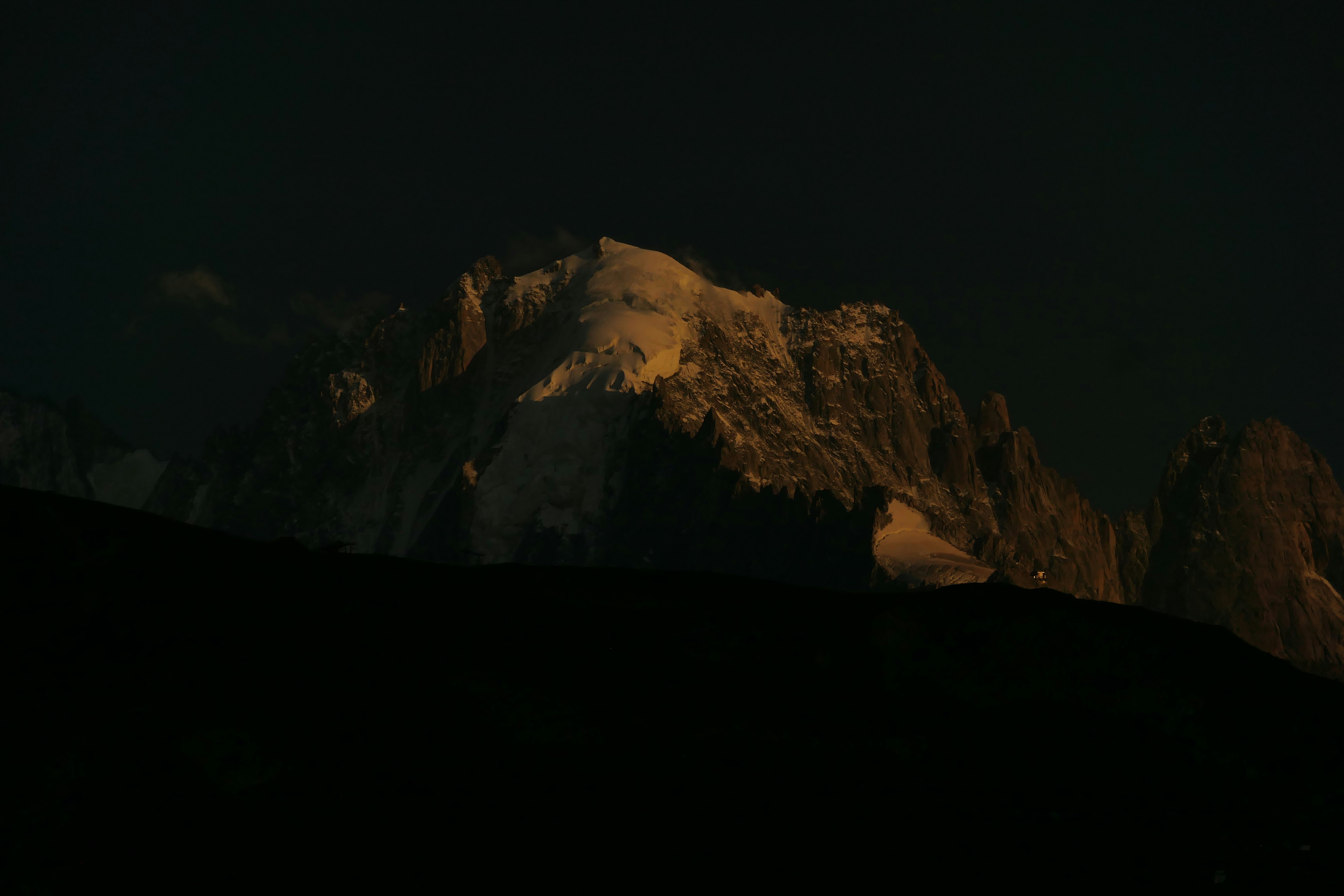 A snow covered mountain at night with a dark sky photo – Free Chamonix ...