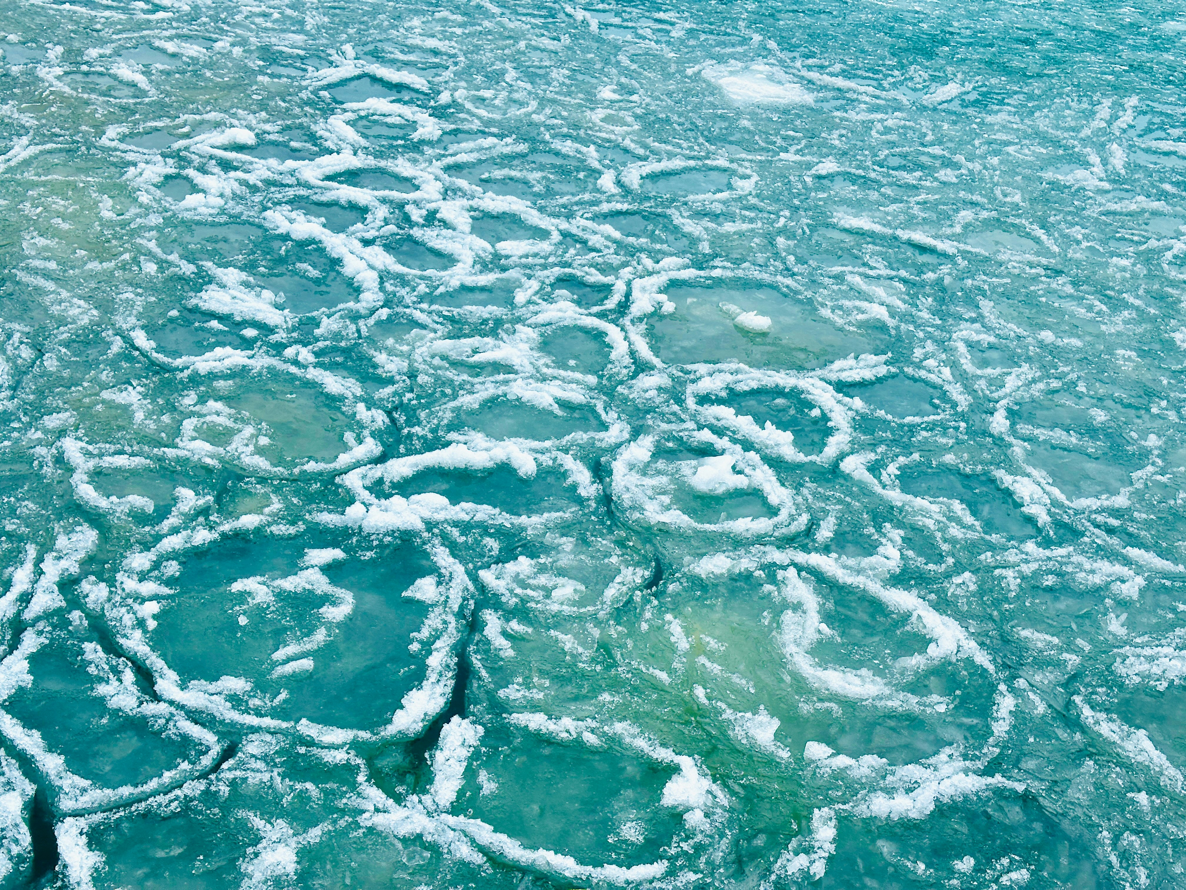 Turquoise Ice Rings: Circular Patterns on a Frozen Surface