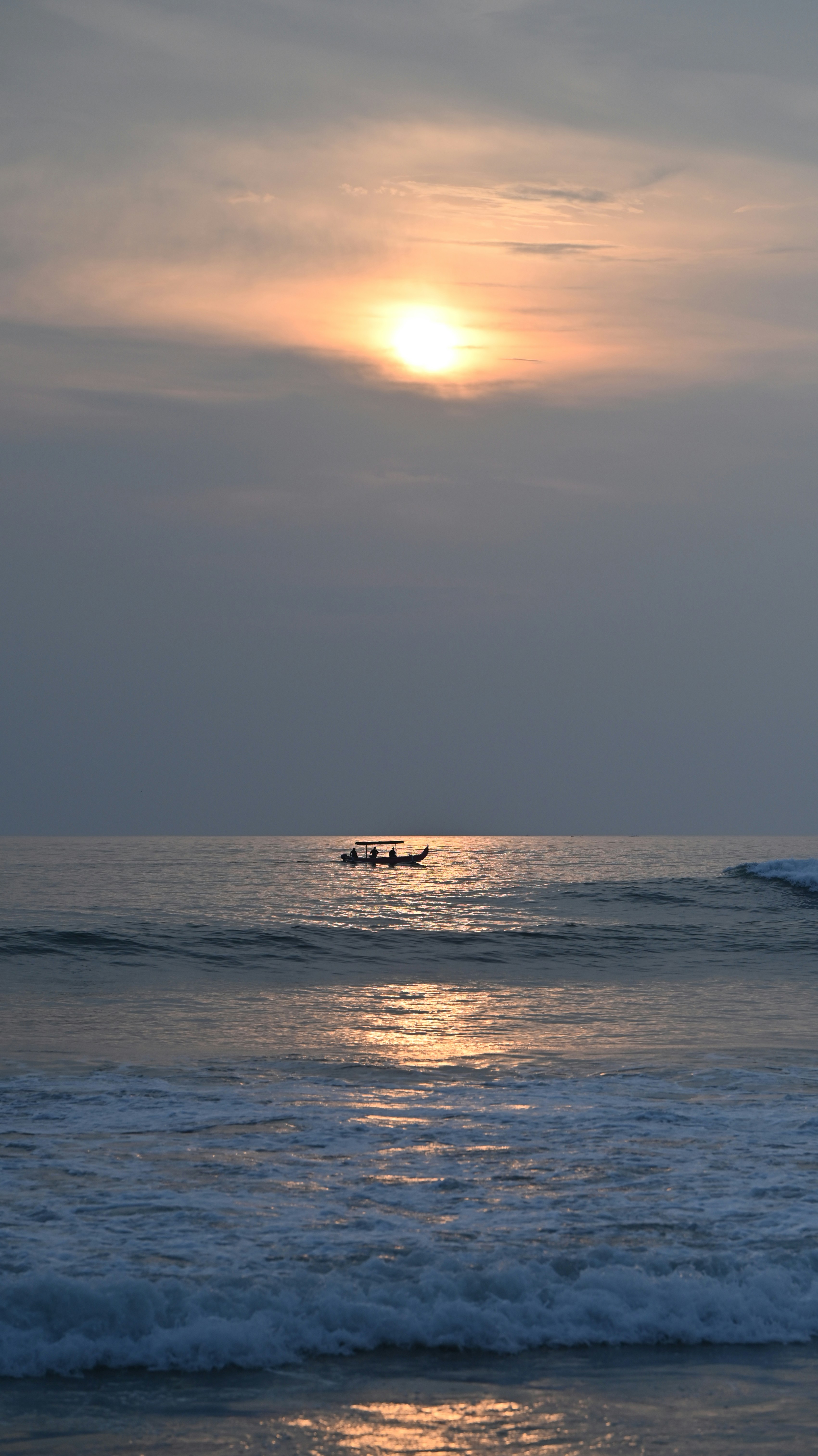 Dusk Crossing: A lone boat traces the sunlit horizon