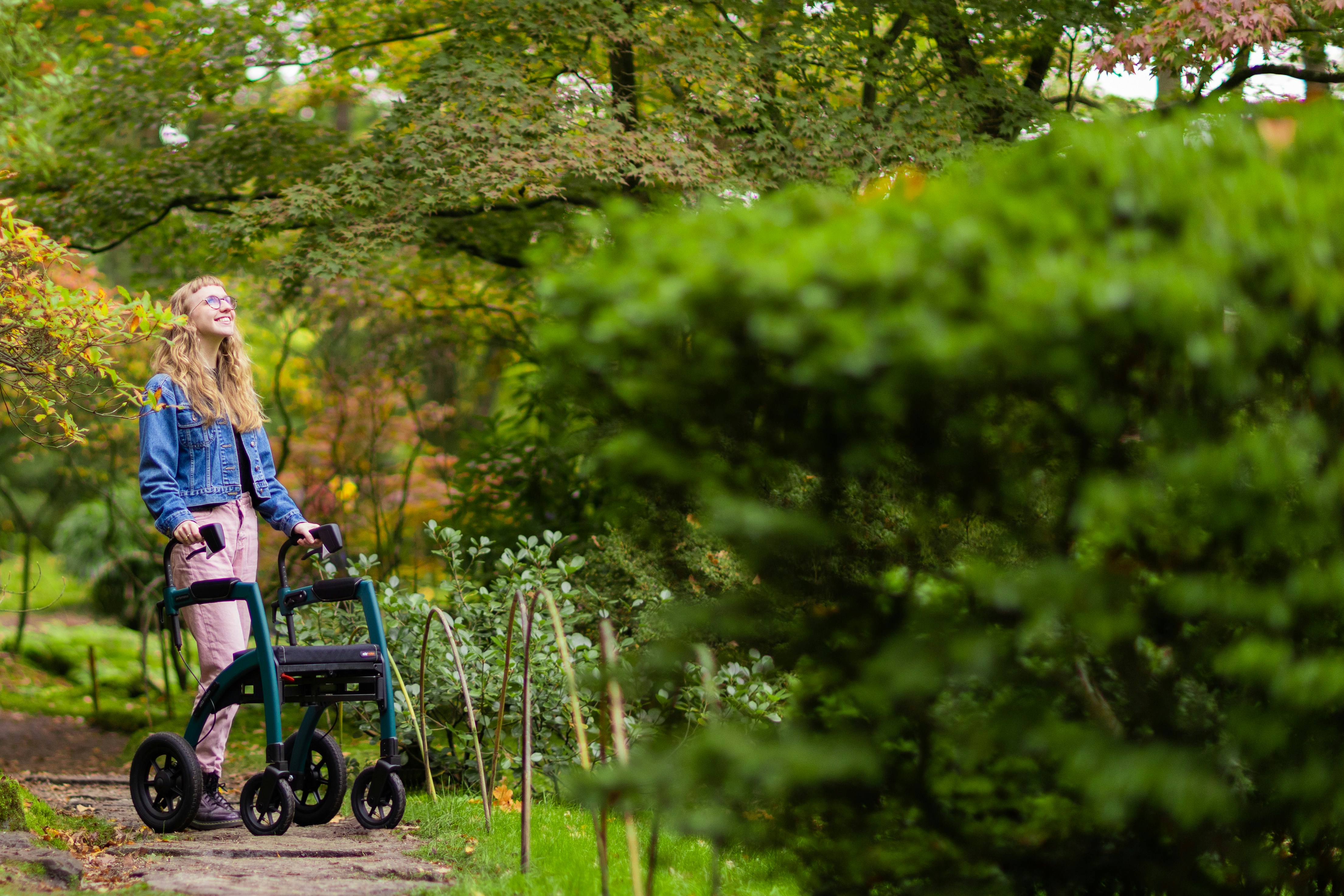 A woman walking with a walker in a park photo – Free Young Image on ...