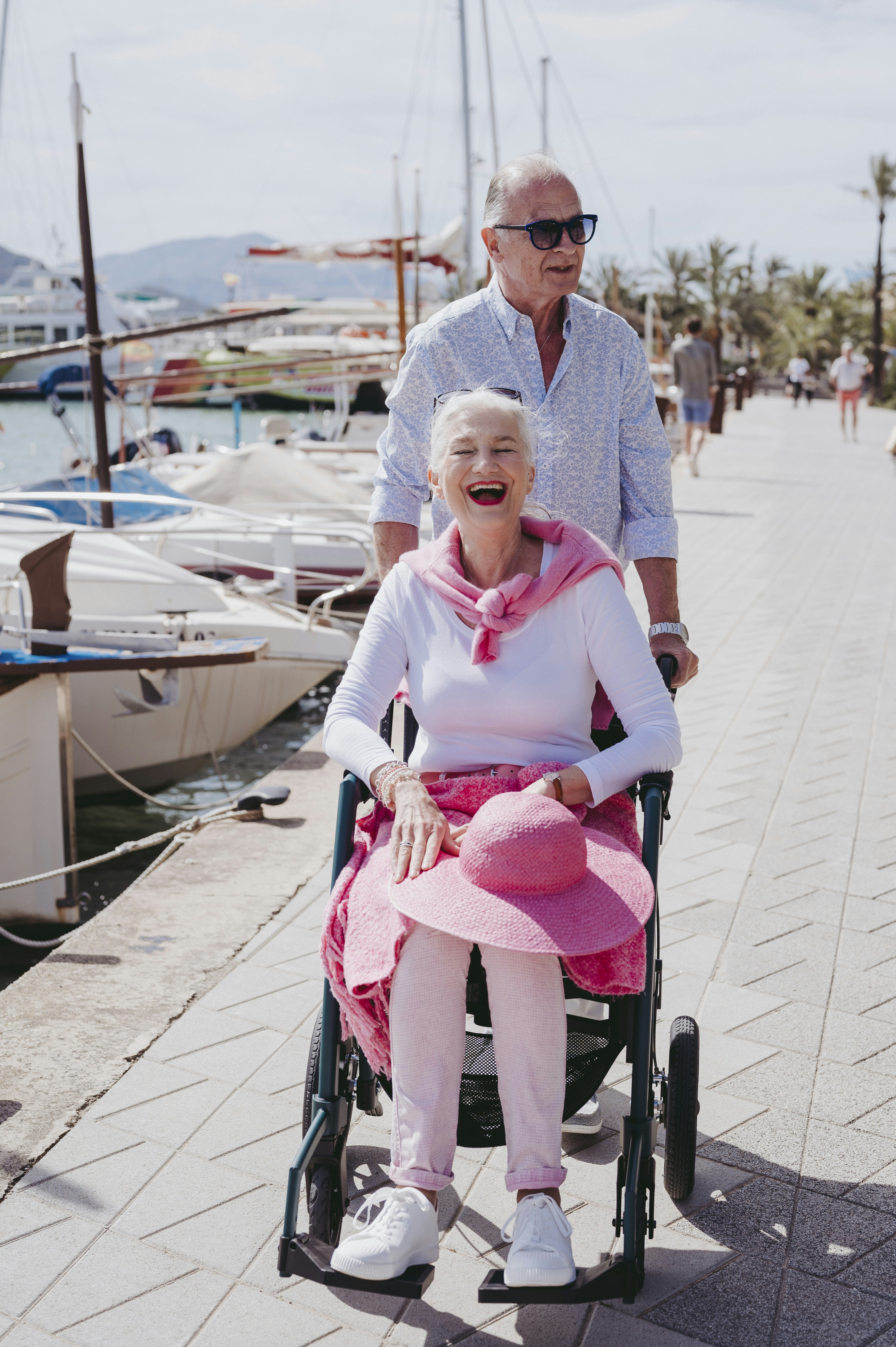 A man pushing a woman in a wheel chair photo – Free Woman Image on Unsplash