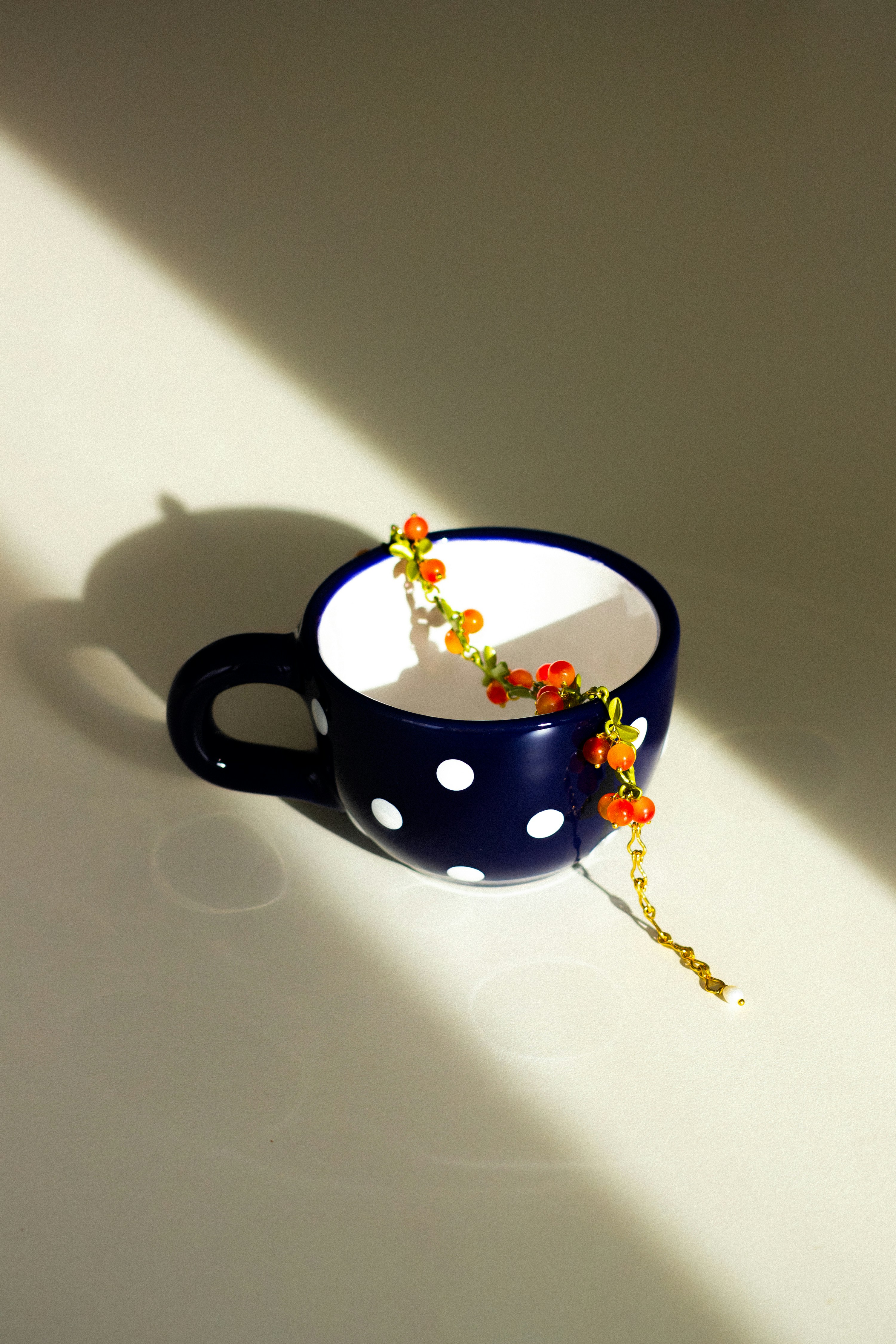 Beaded Cascade on a Polka-Dot Mug in Studio Sunlight