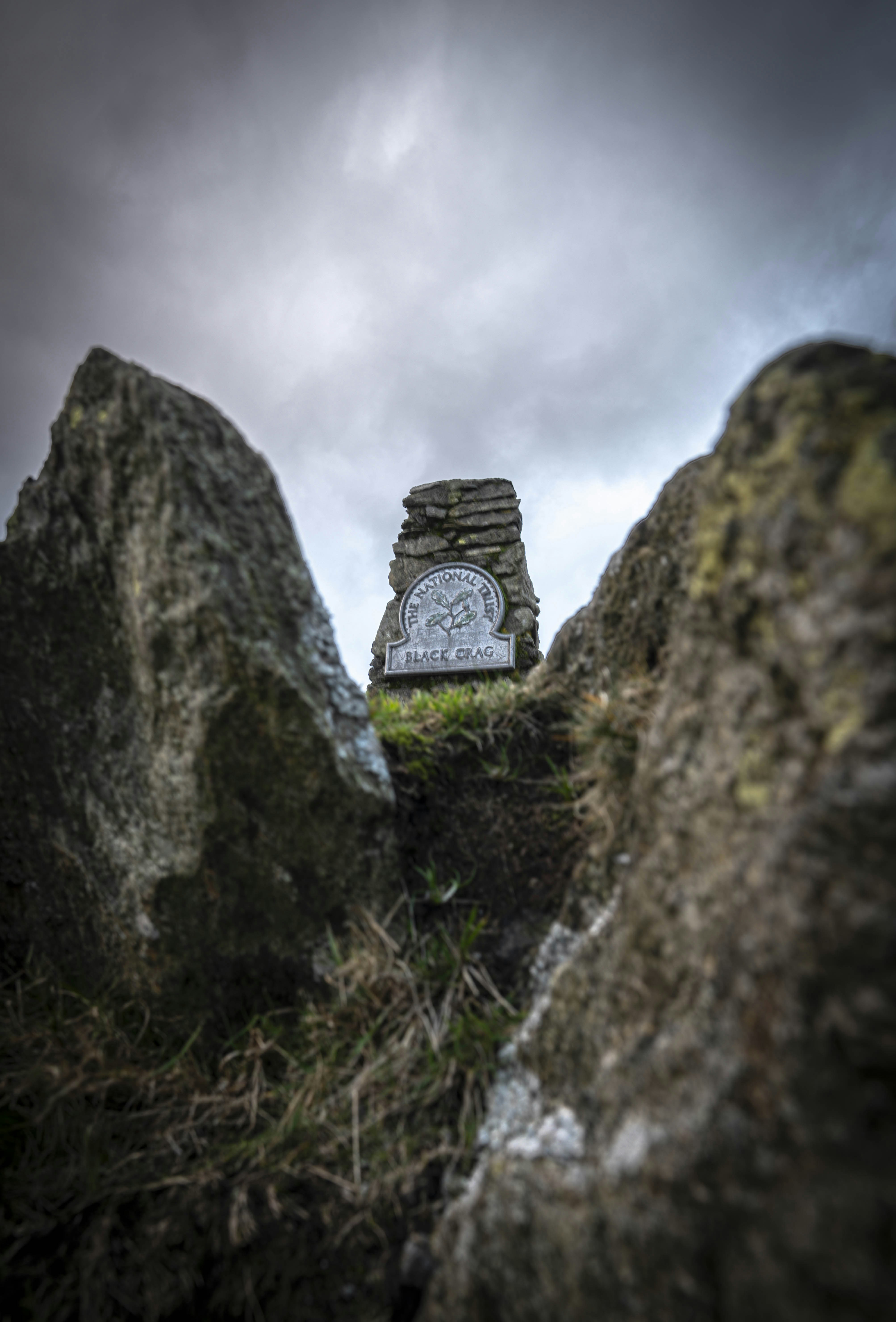 Sentinel at the Ridge: A Weathered Marker Between Stone Fangs