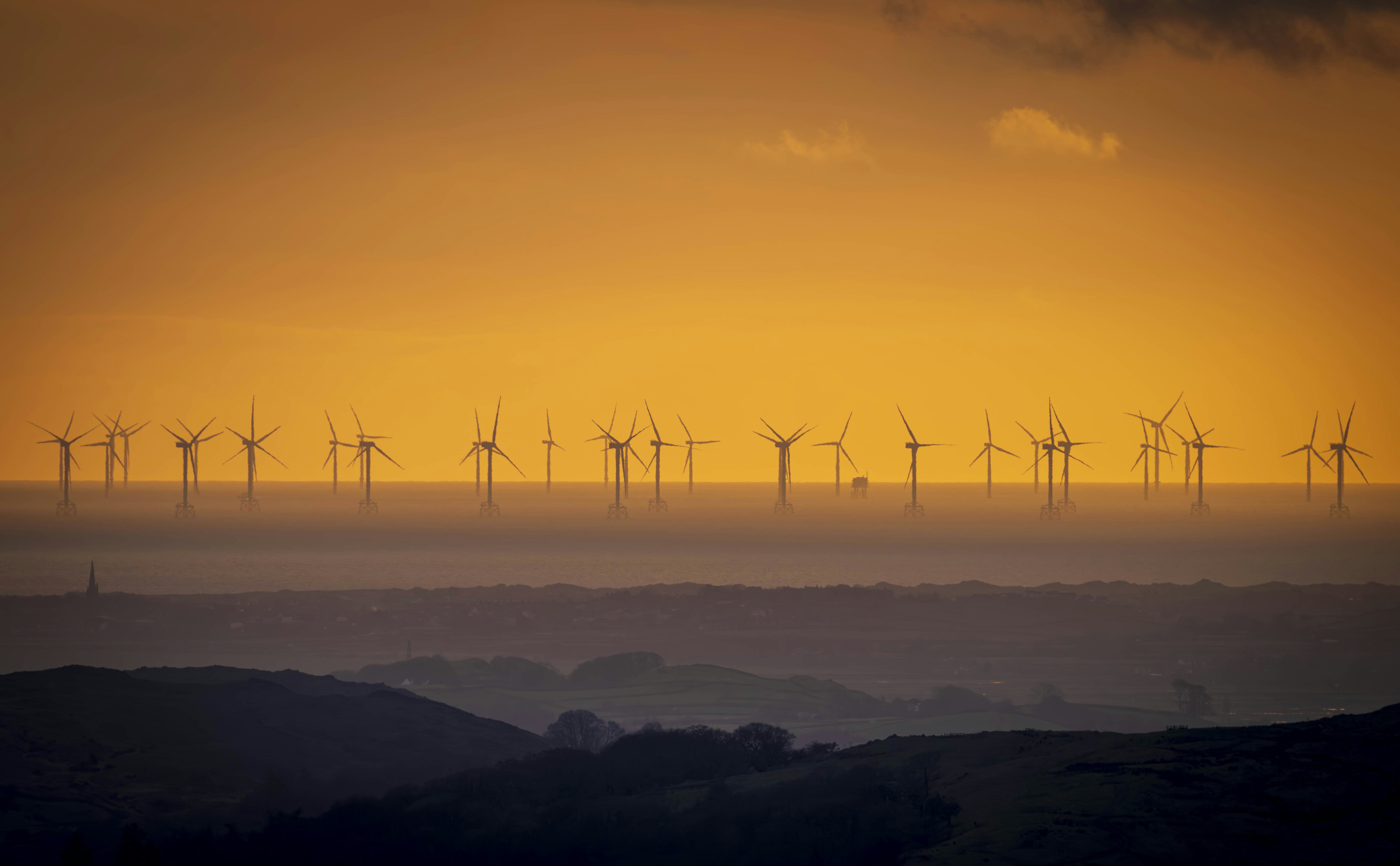 A group of windmills on a hill at sunset photo – Free National park ...