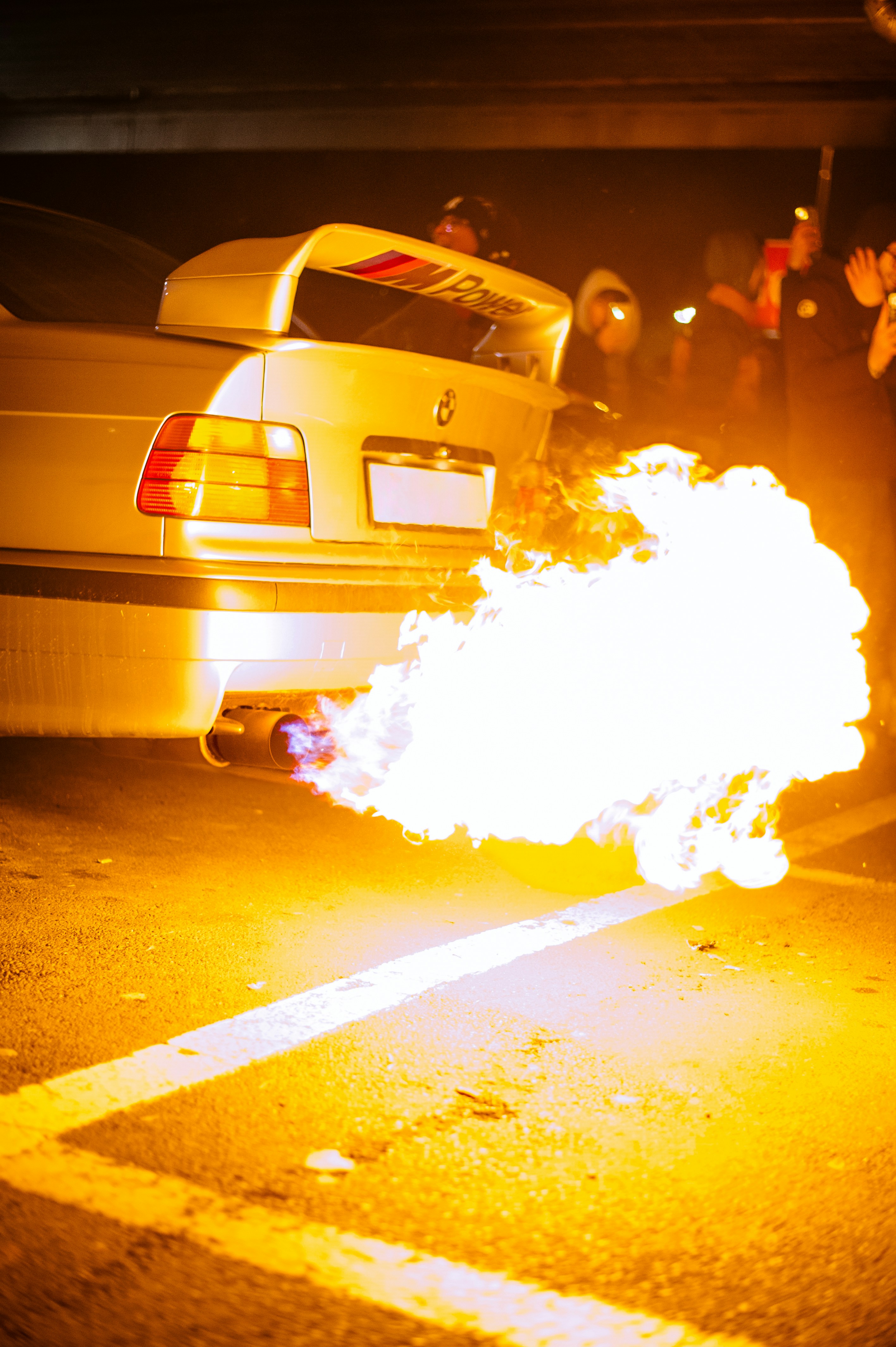 BMW Night Burnout Blaze: Fiery Exhaust Illuminates the Night Street Crowd