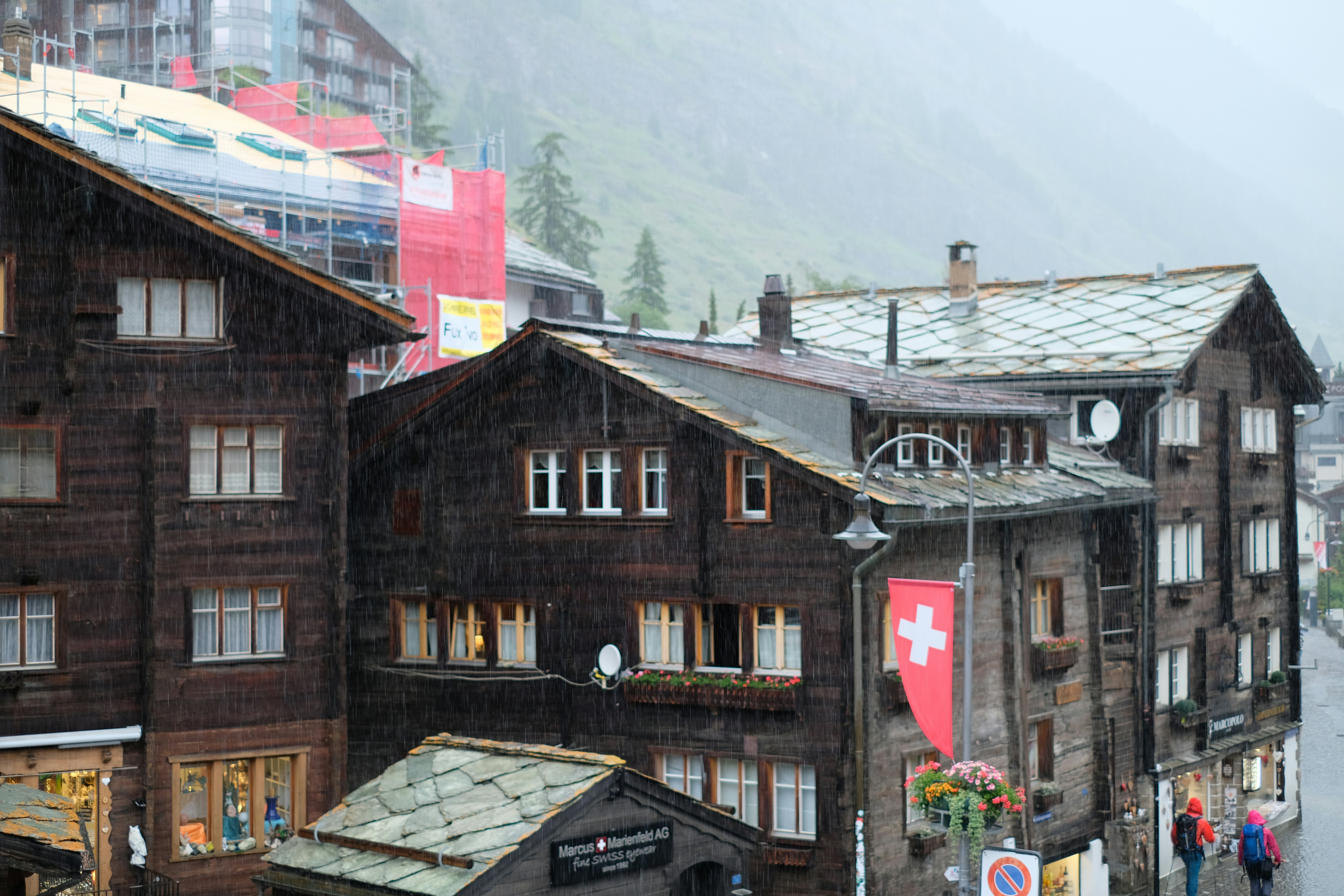 Swiss Alpine Village Facade Under a Misty Fold