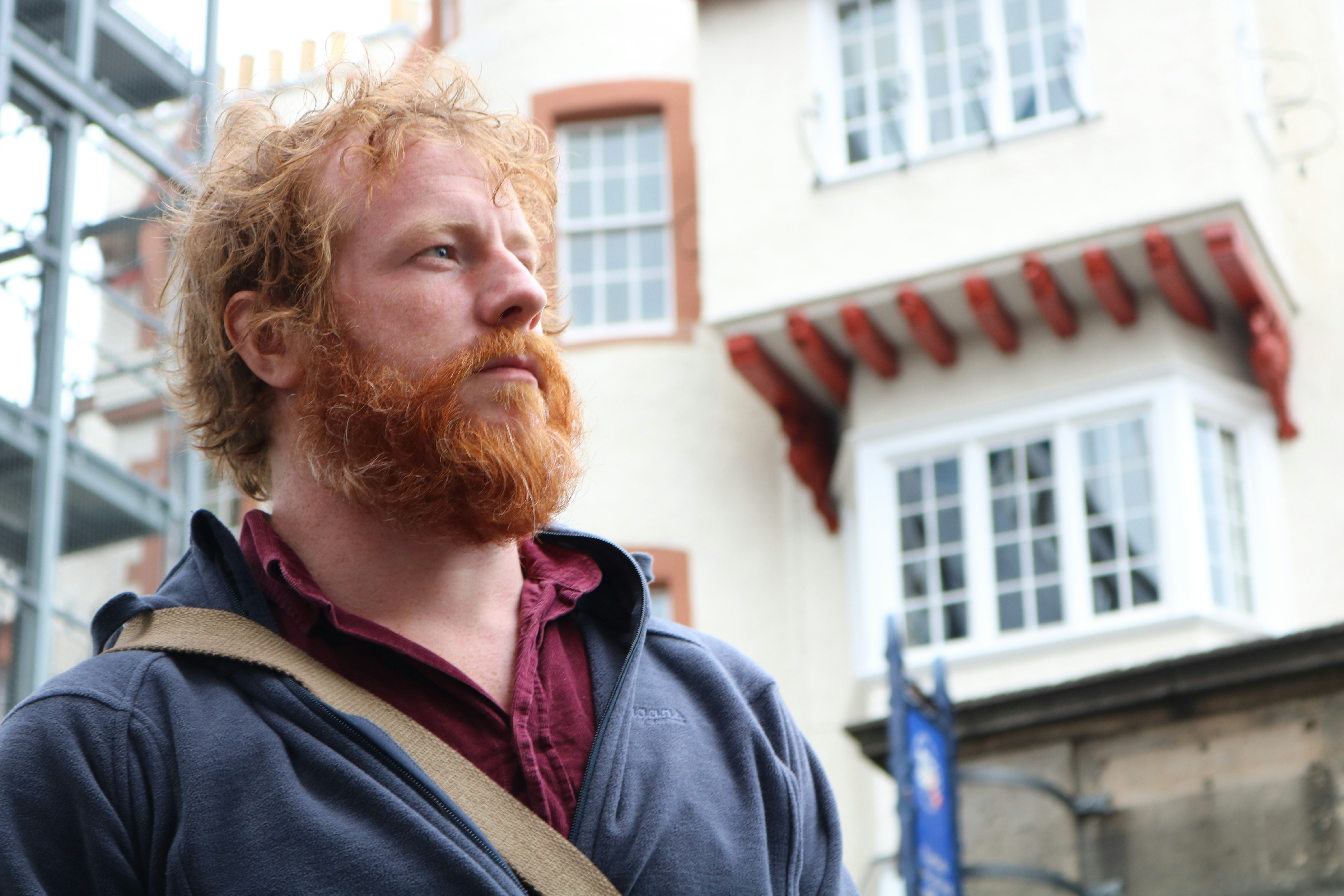 Red‑Bearded Messenger in Urban Light