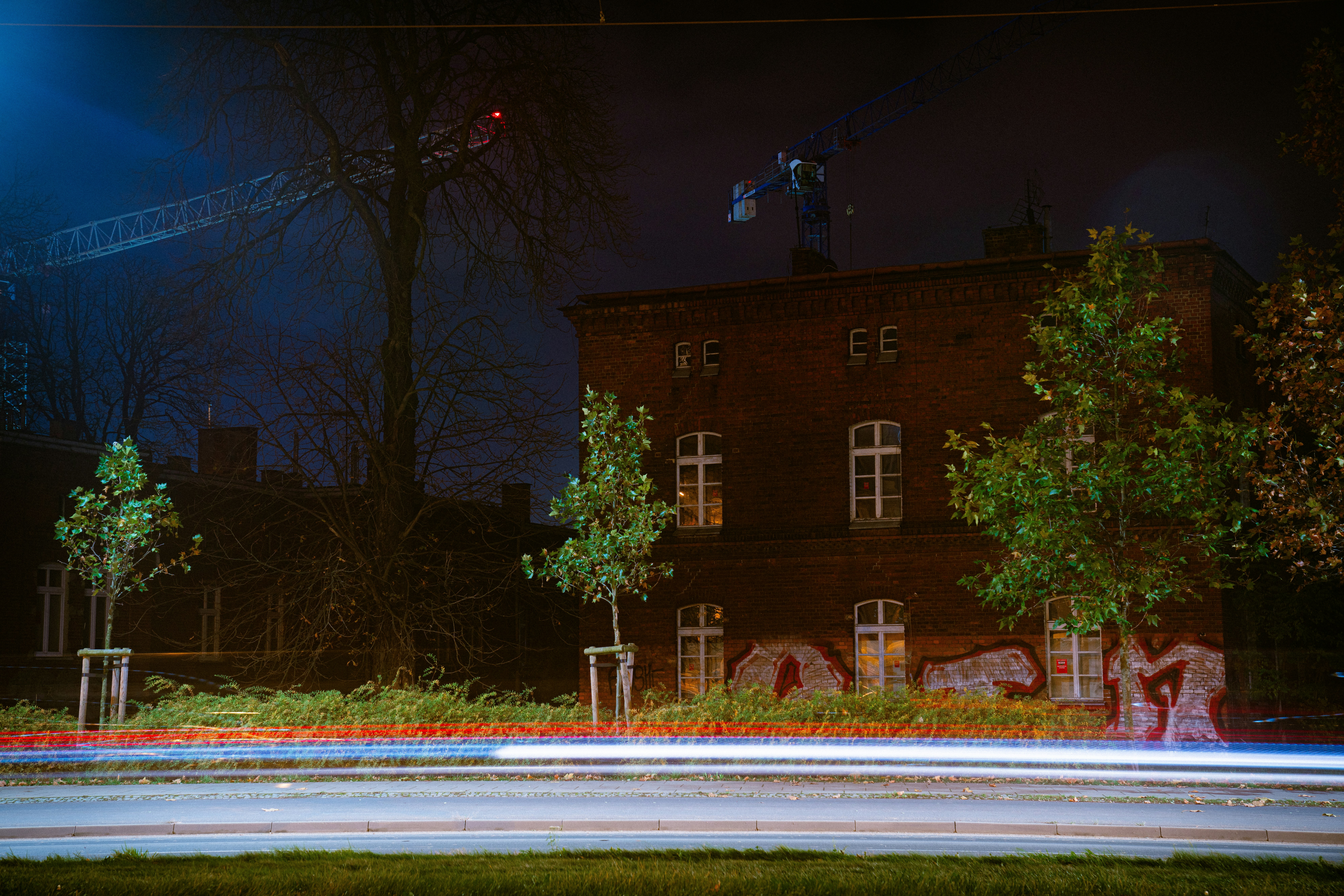 Nighttime Brick Building with Graffiti and Light Trails
