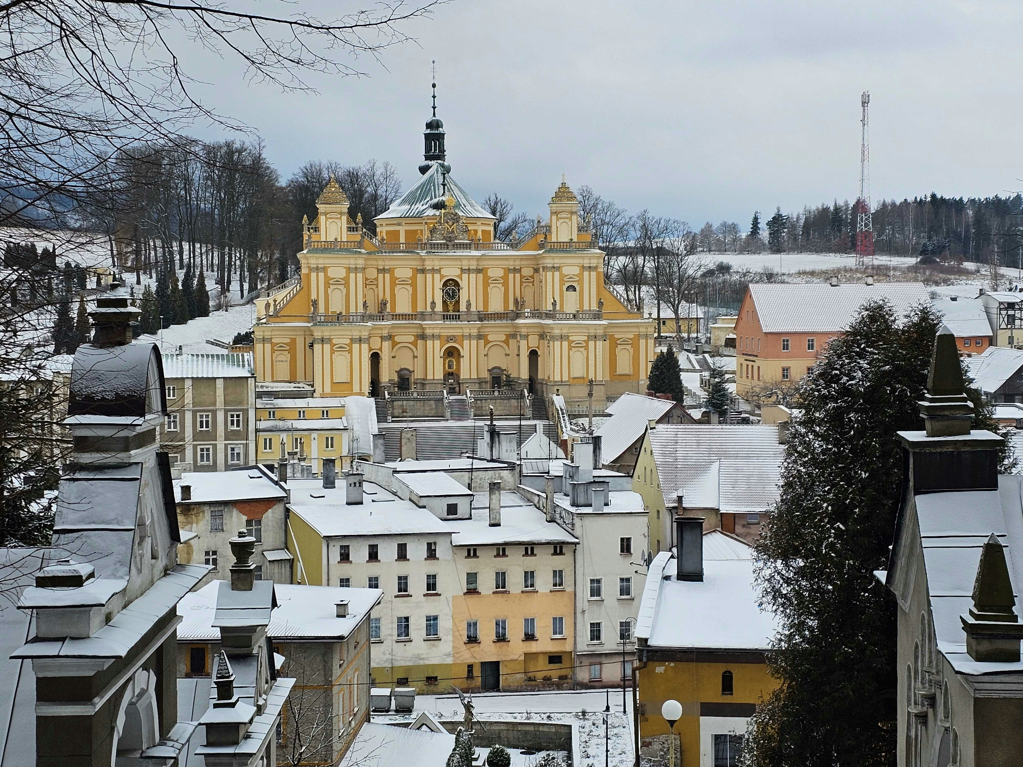 Historic architecture stands majestically against a snowy landscape, highlighting the contrast between the warm tones of the building and the cool, white surroundings.