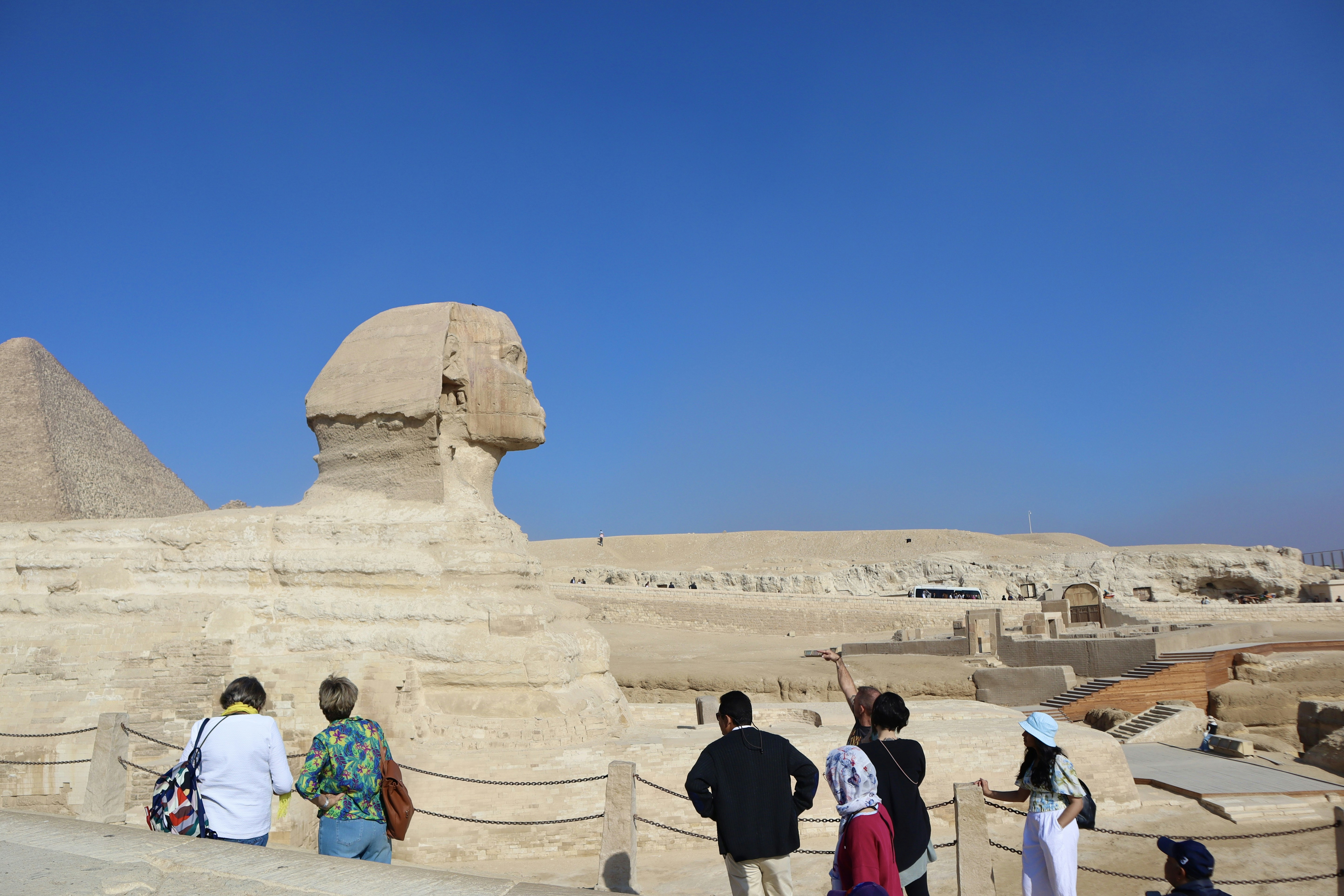 A group of people standing in front of a sphinx photo – Free Adult Image on Unsplash