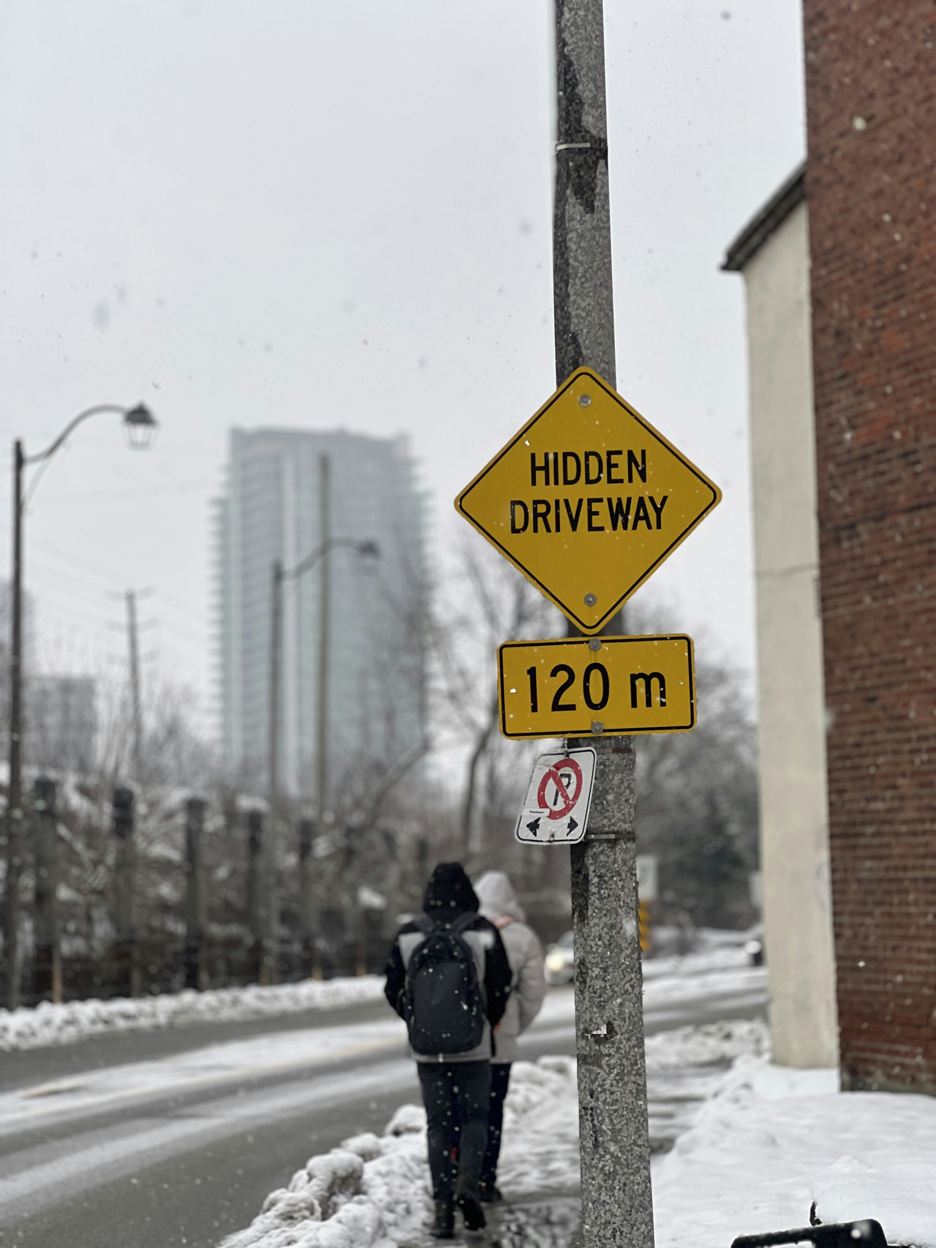Hidden Driveway Sign on a Snowy Street: A Quiet City Walk