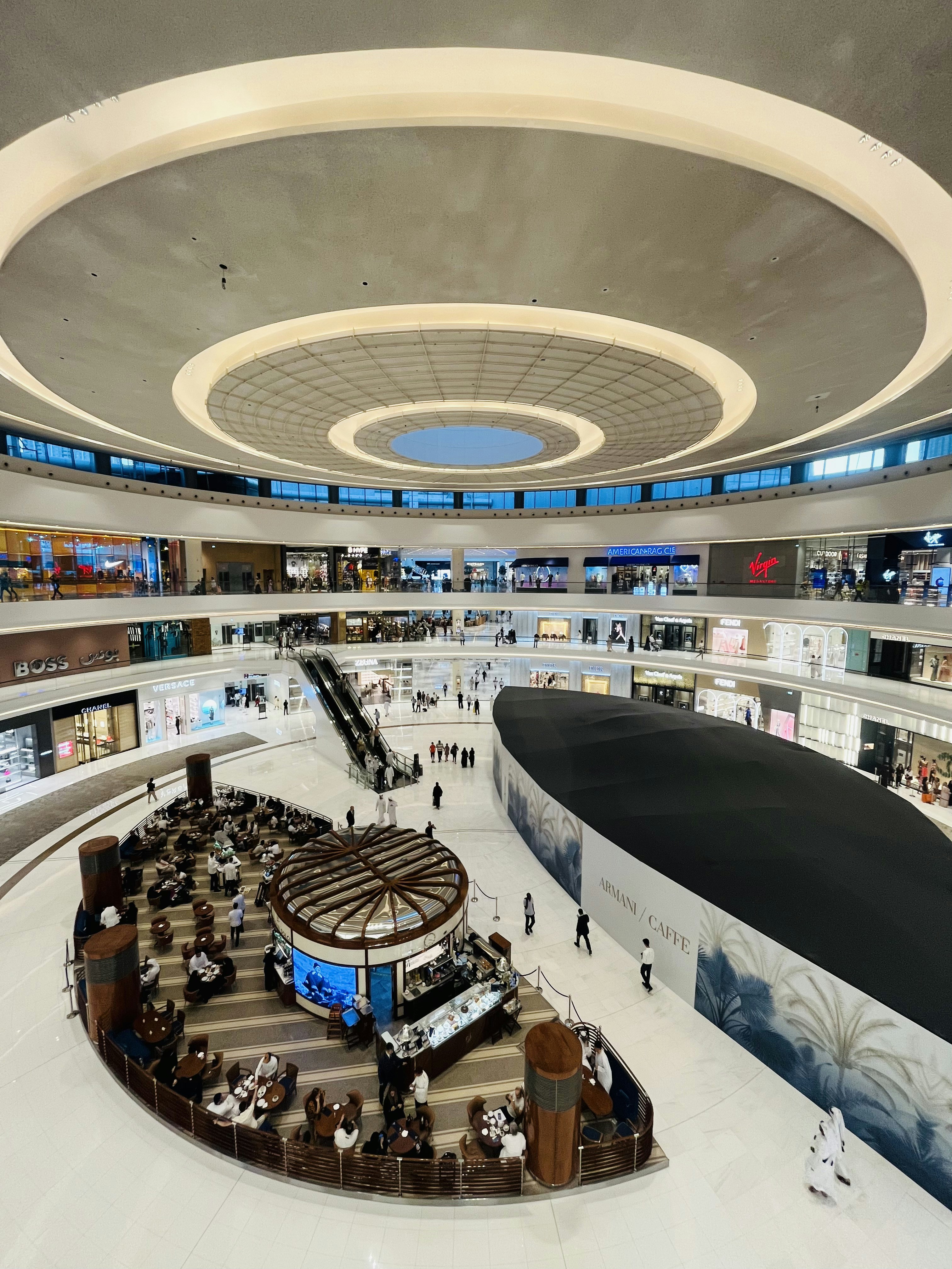 A large building with people walking around inside of it photo – Free ...