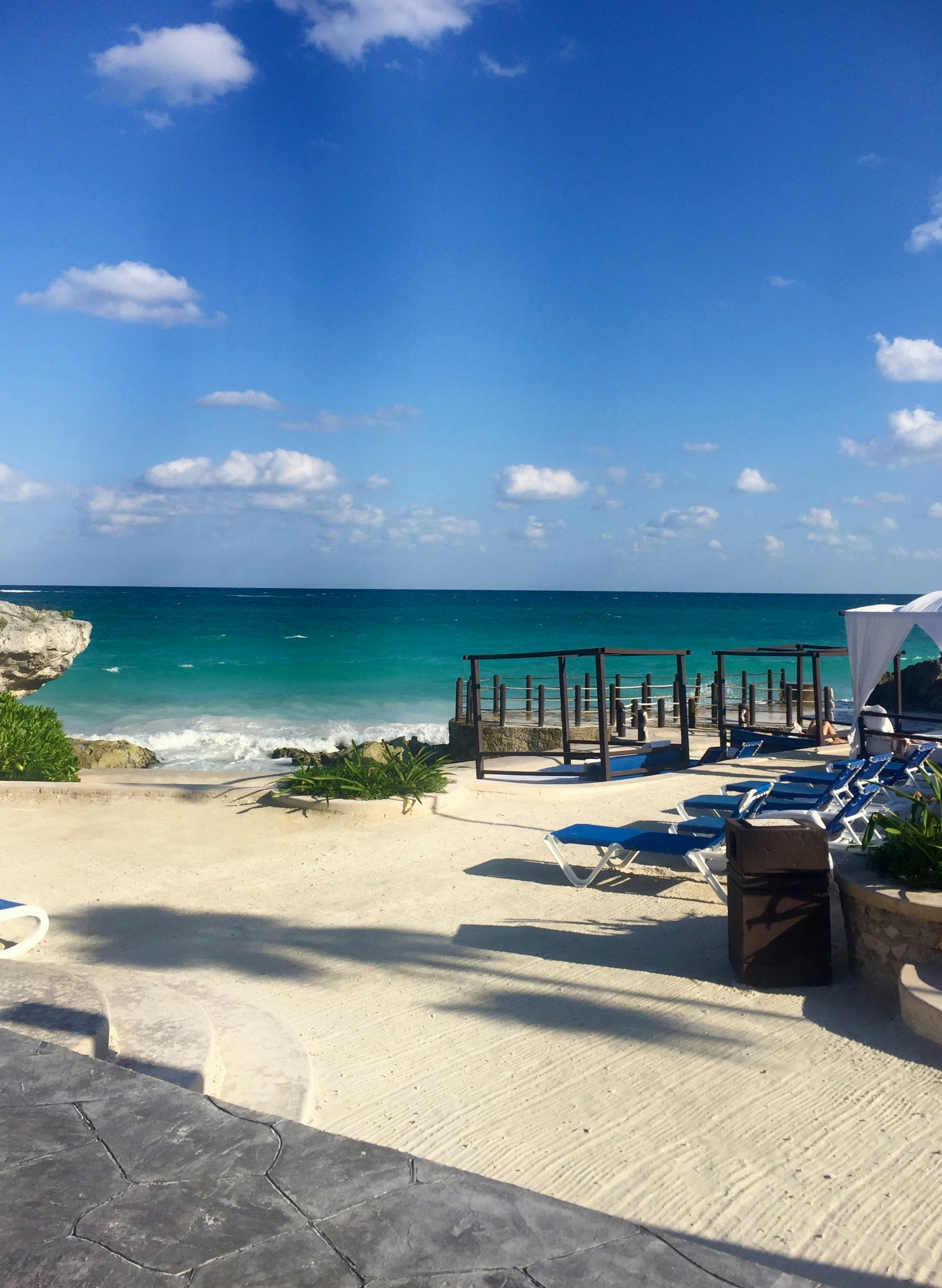 Turquoise Horizon: A Wooden Pier Reaches Over a Sunlit Caribbean Beach