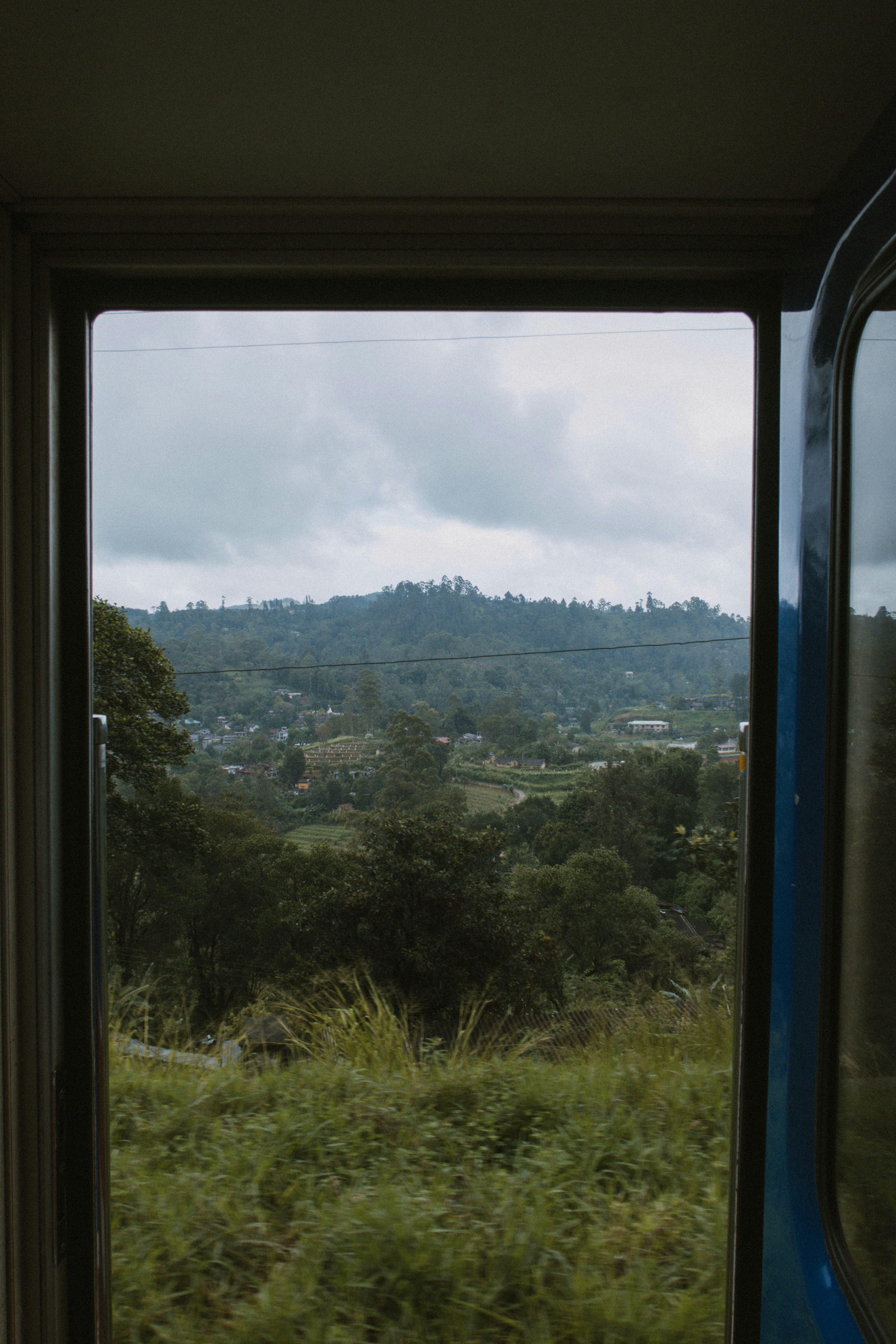 A view out a train window of a lush green valley photo – Free Forest ...