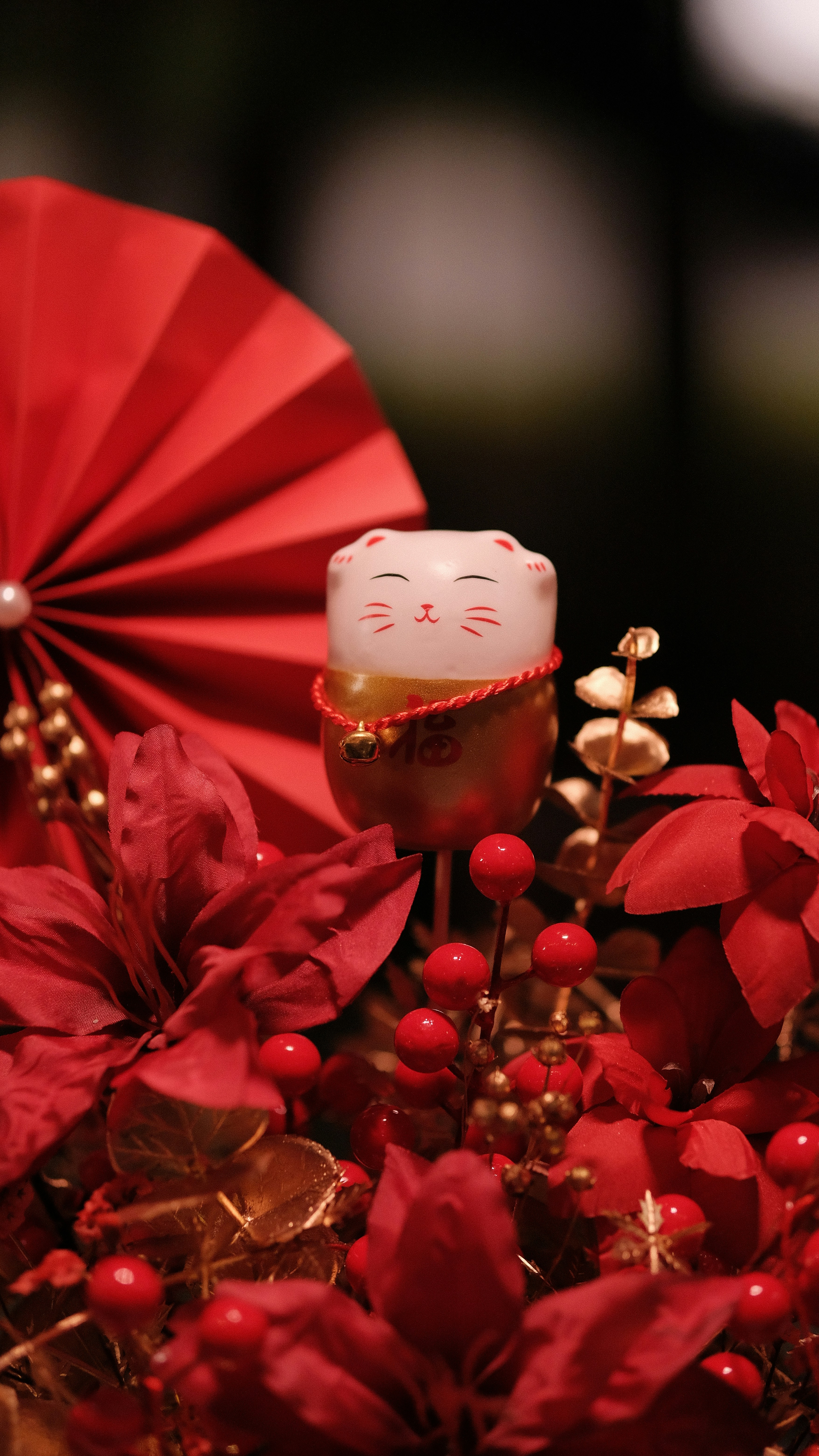 Crimson Florals Frame a Lucky Cat Under a Papercraft Parasol