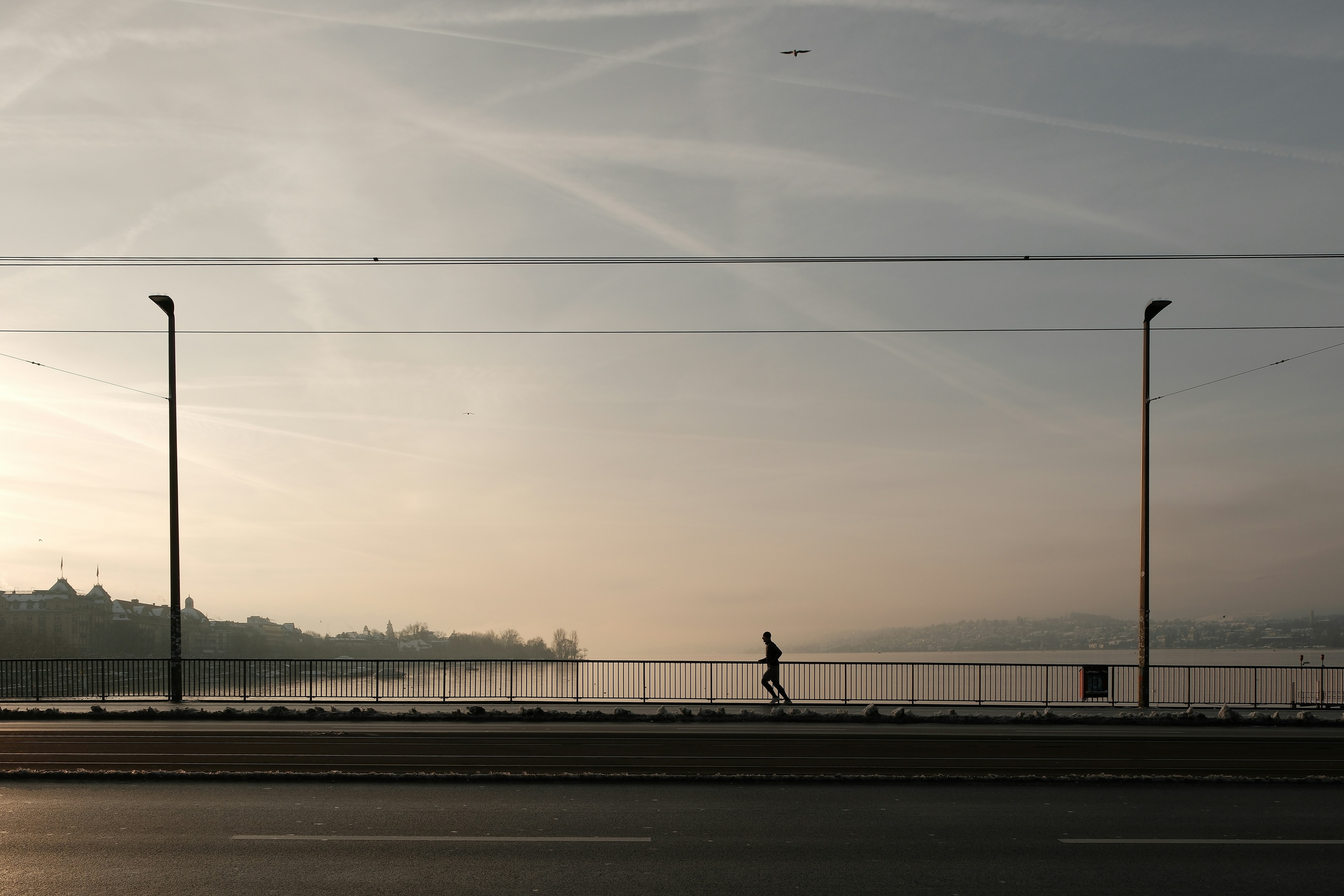 A person walking across a bridge over a body of water photo – Free ...