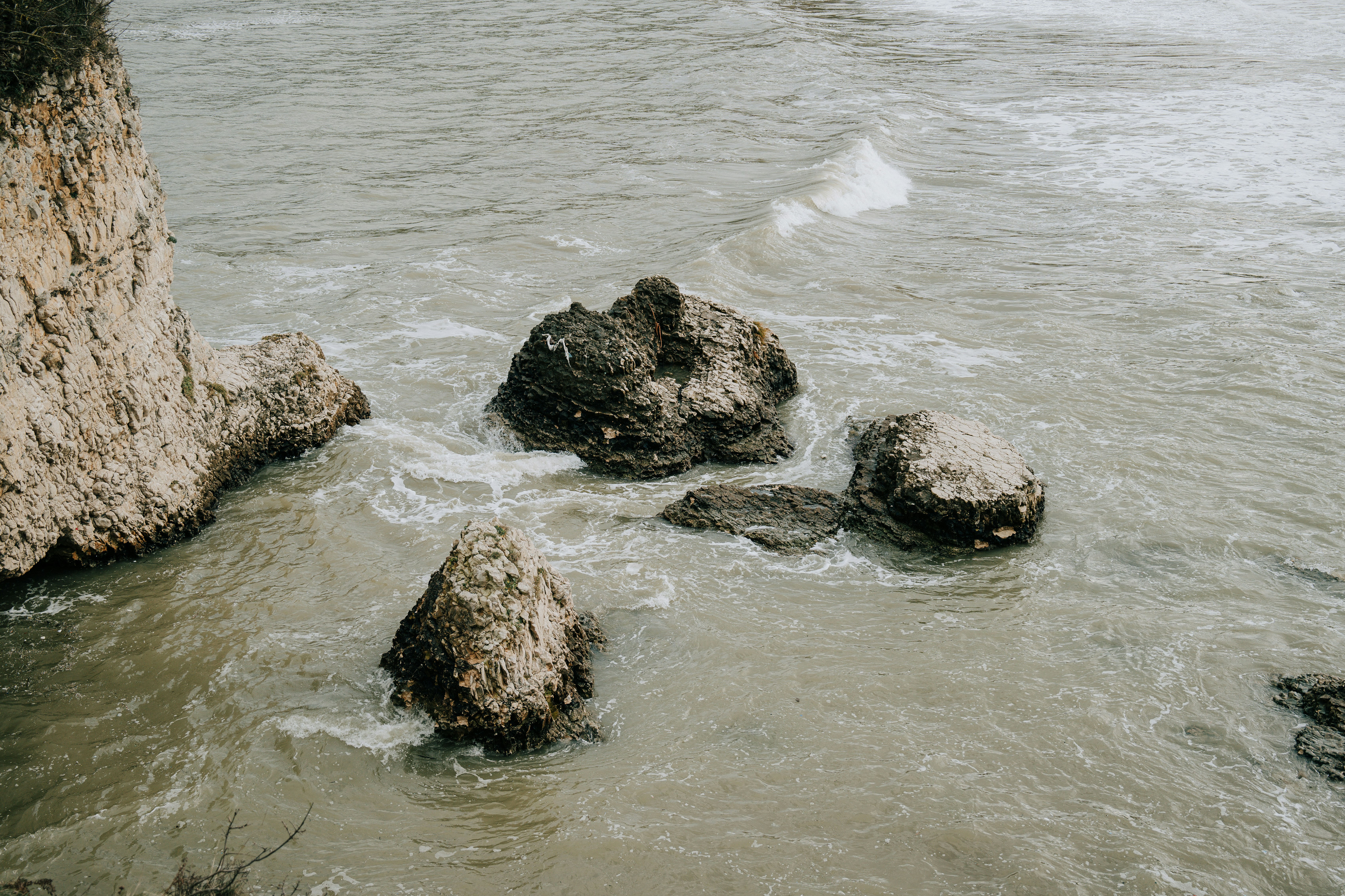 Rugged Sentinels: Stones Hold Ground Against Tidal Whispers