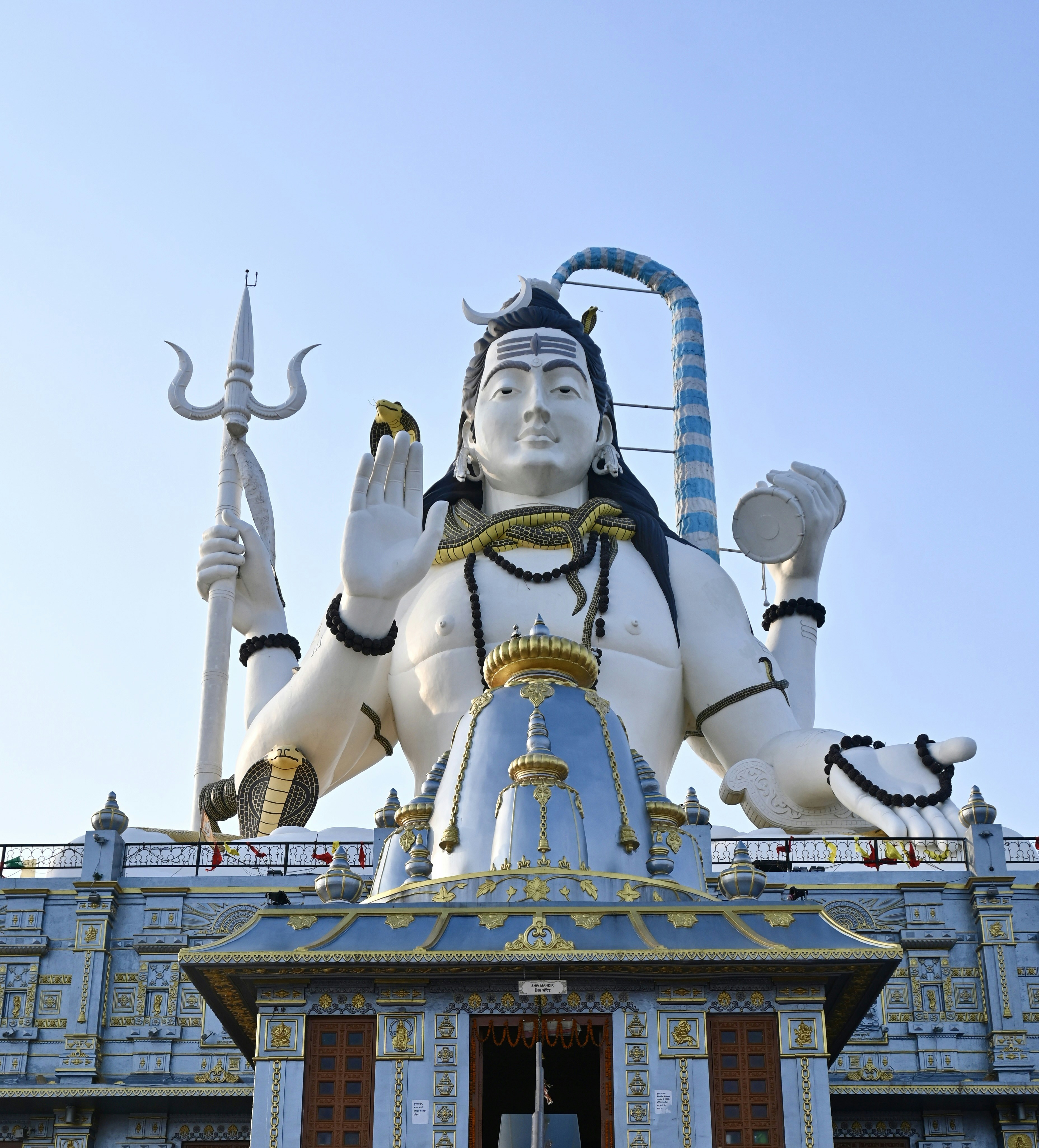 A large statue of a hindu god on top of a building photo – Free India ...