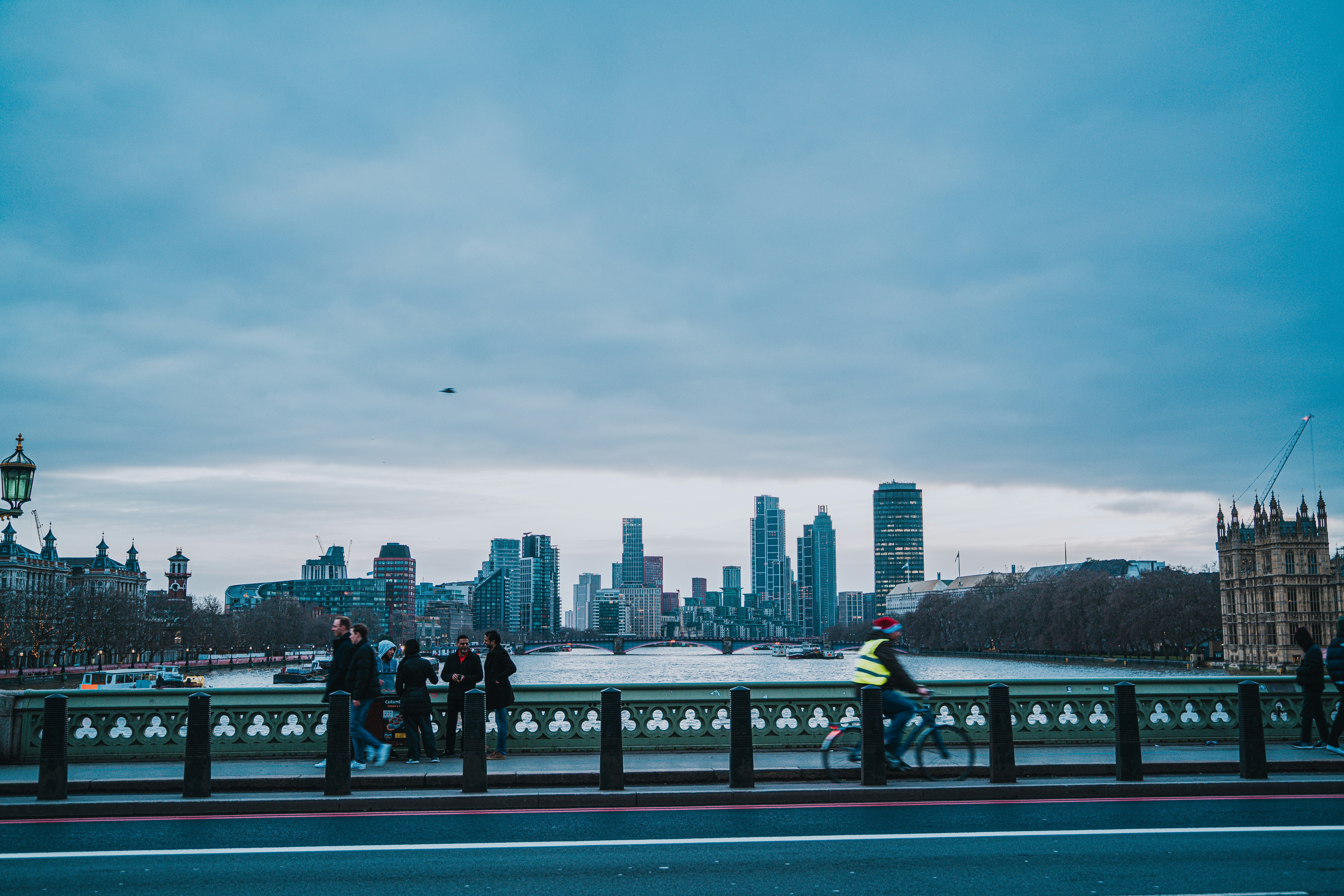 A group of people walking across a bridge photo – Free London Image on ...