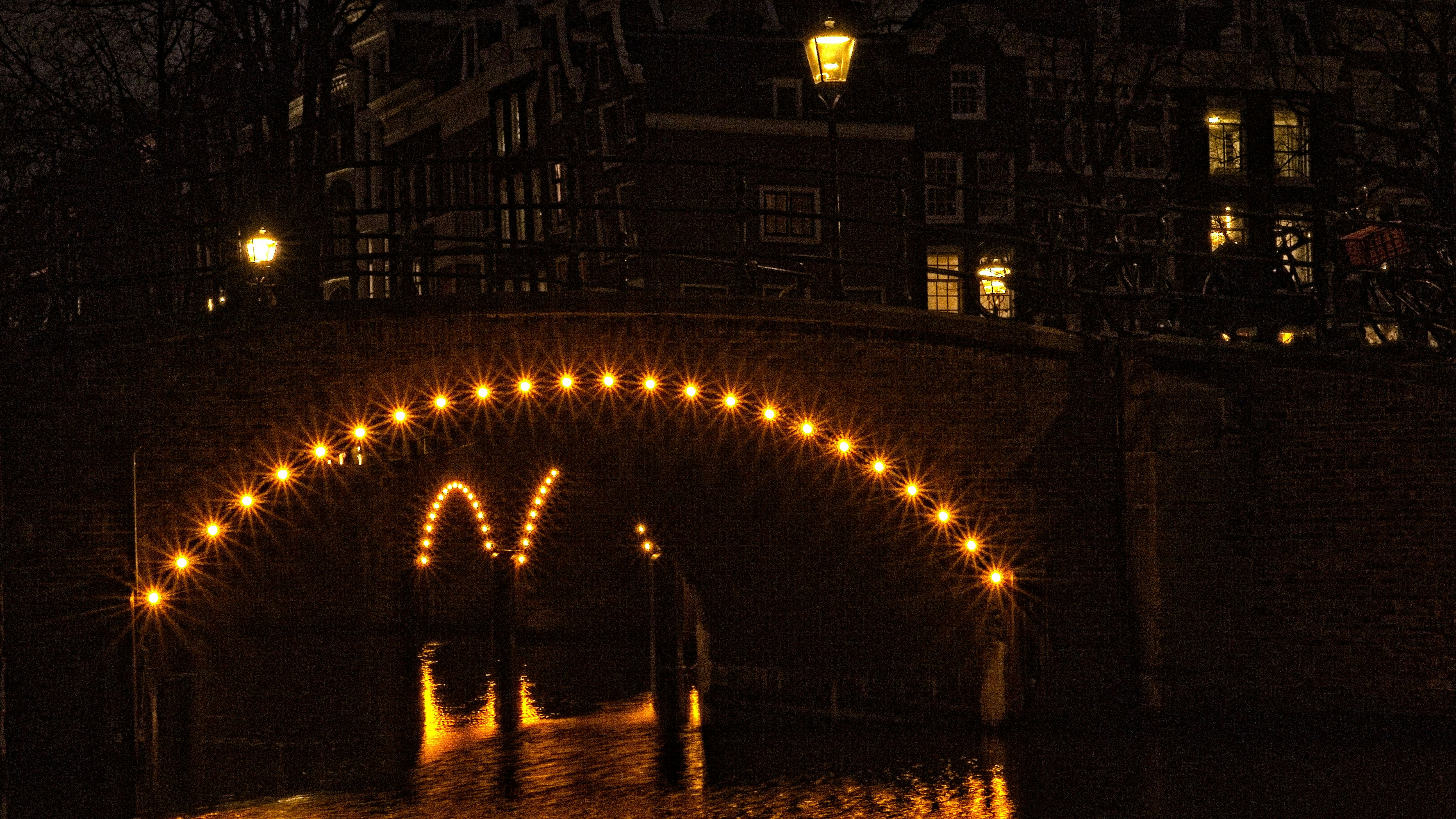 Golden Arc Over the Canal: Night Lights on a Quiet Bridge