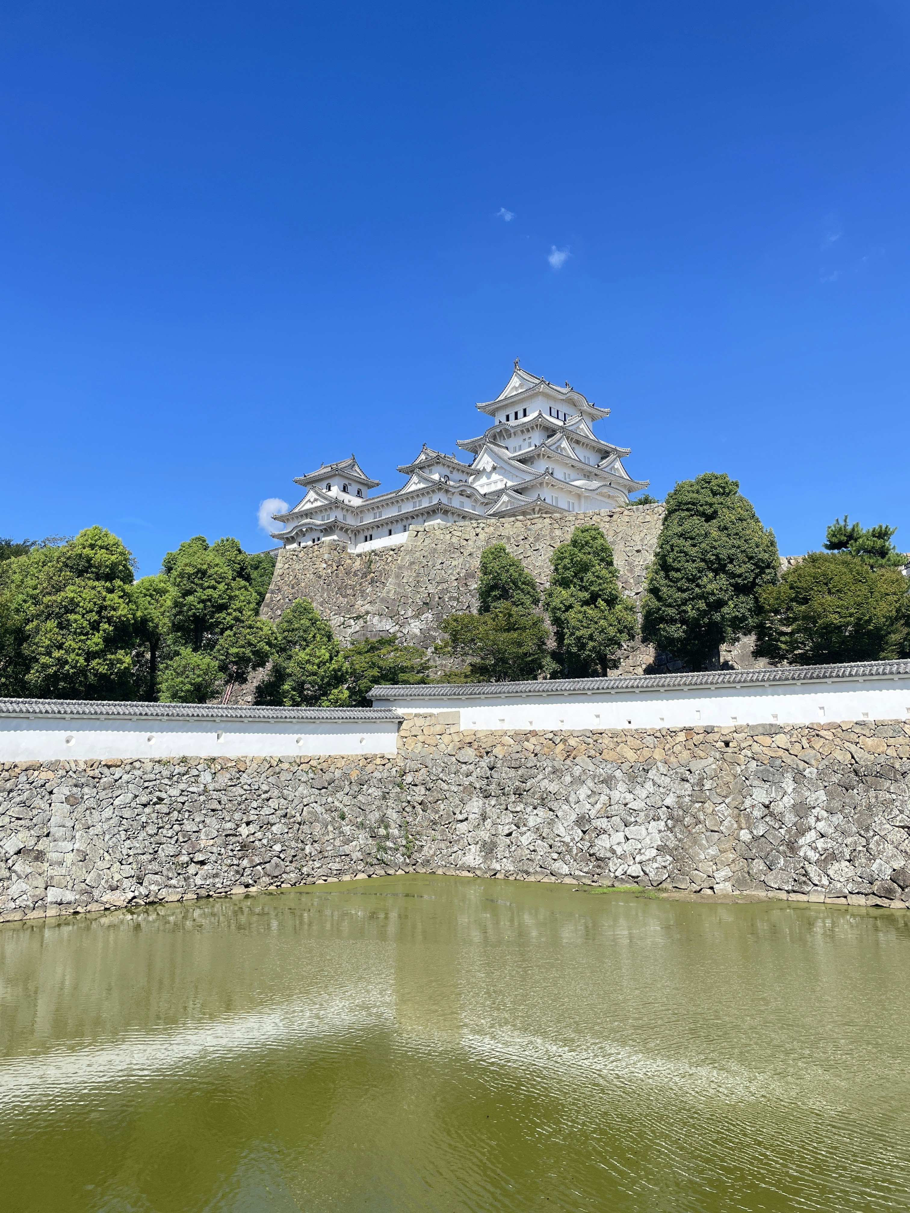 White Fortress Rising Above Stone Walls Under a Crisp Azure Sky