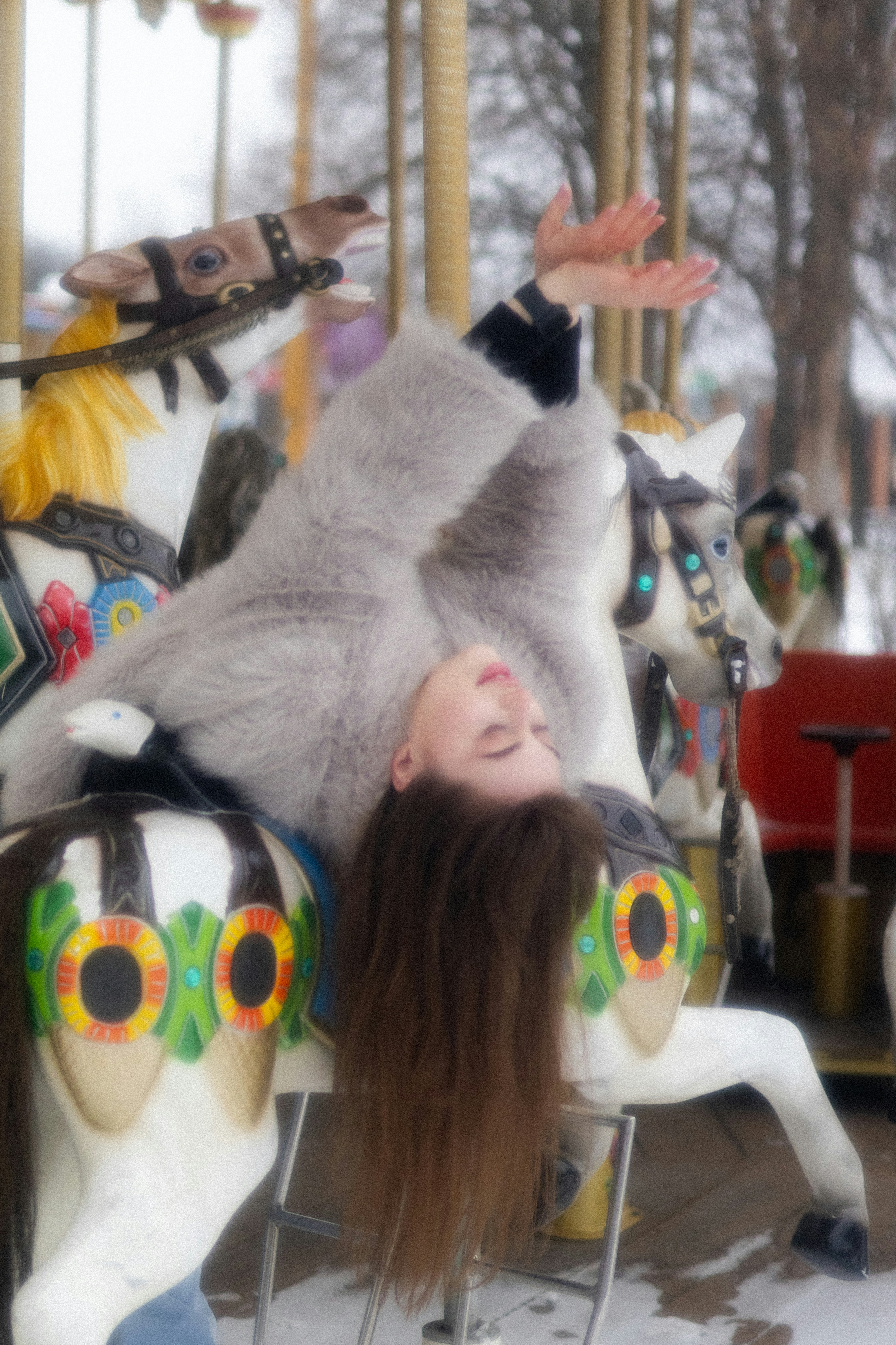A woman laying on top of a merry go round photo – Free Portrait Image ...