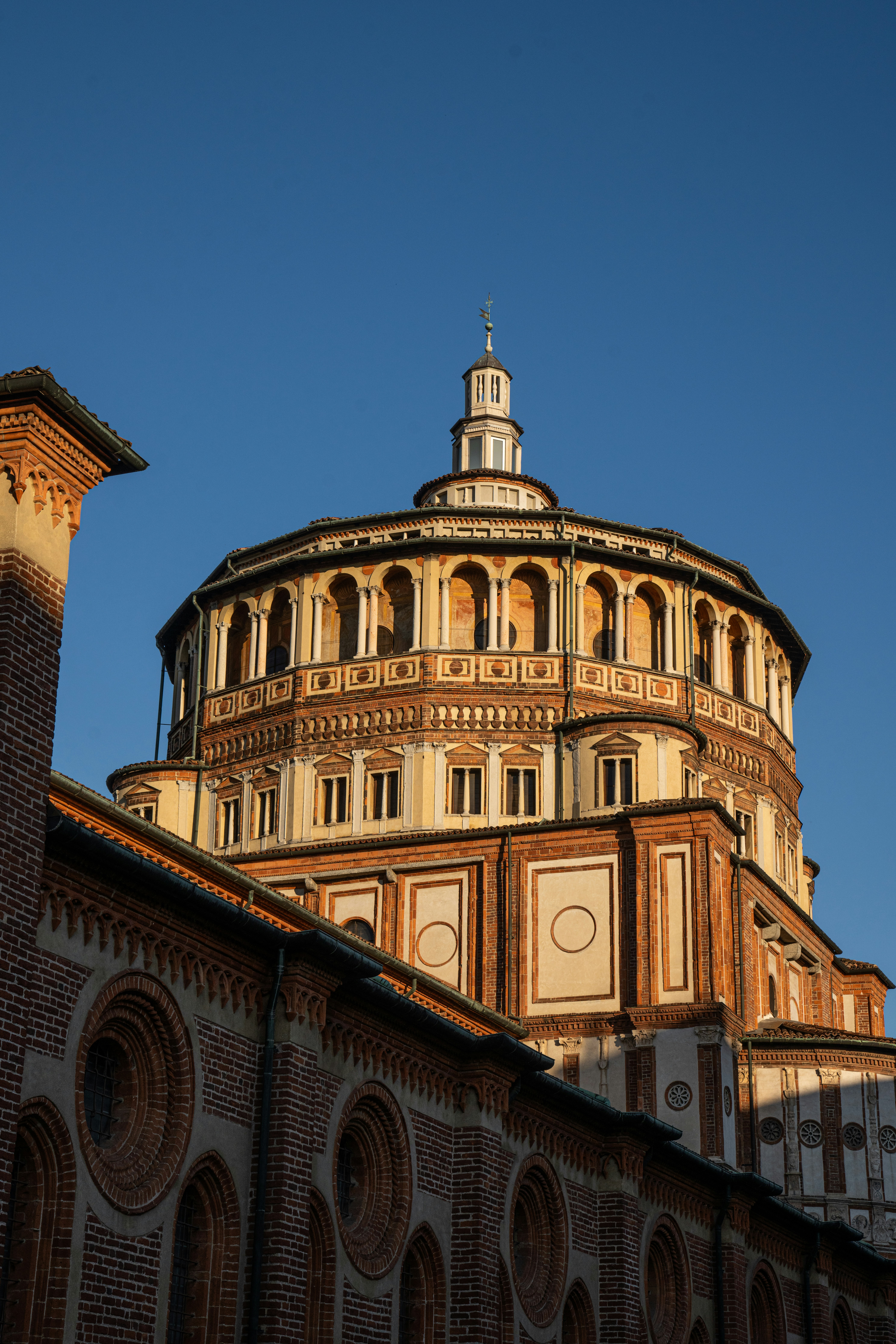 Brick Crown Dome Amid Arched Facades Against a Pristine Blue Sky