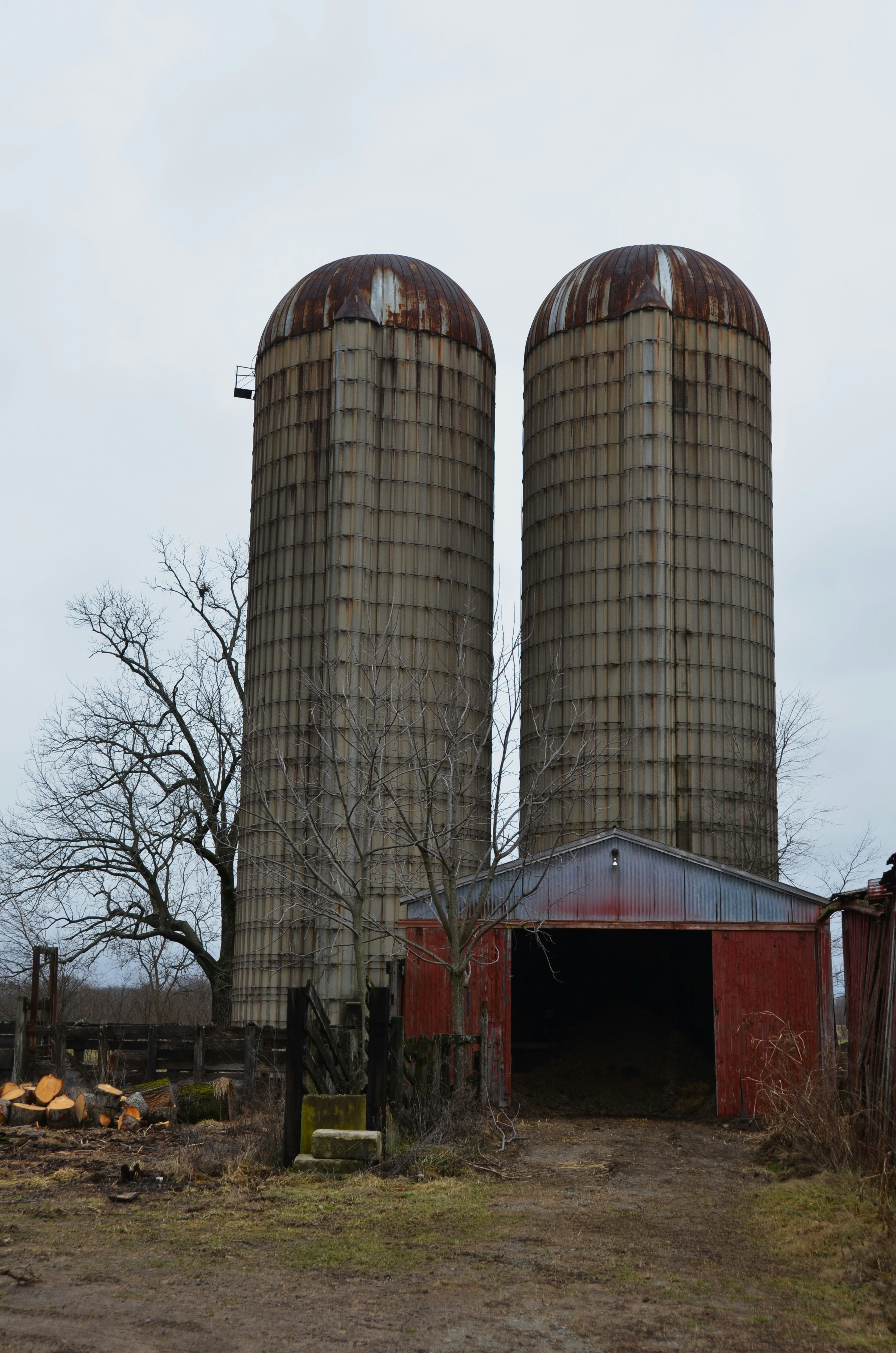 A couple of large silos sitting next to each other photo – Free ...