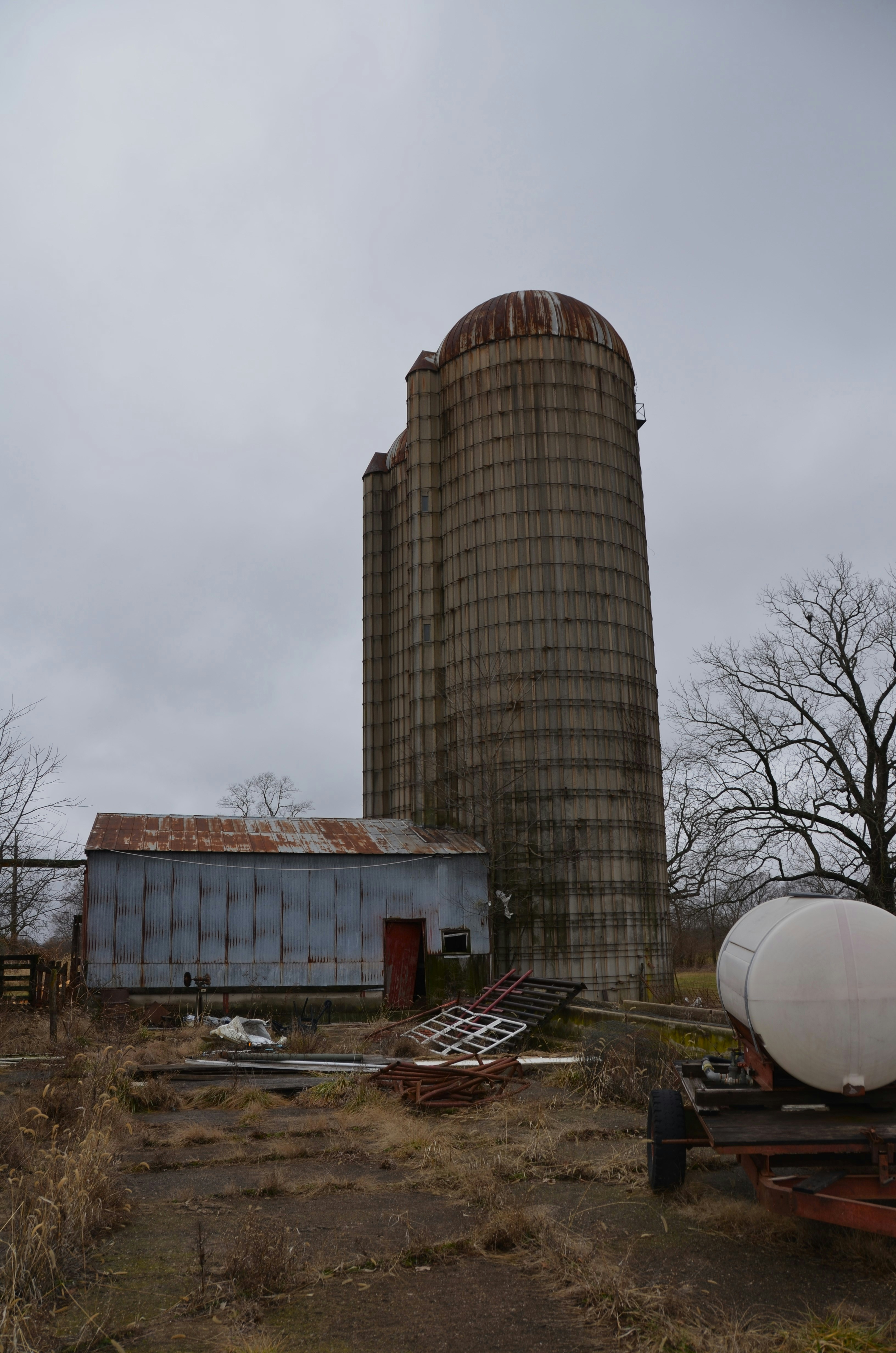 A large silo sitting next to a building photo – Free Outdoors Image on ...