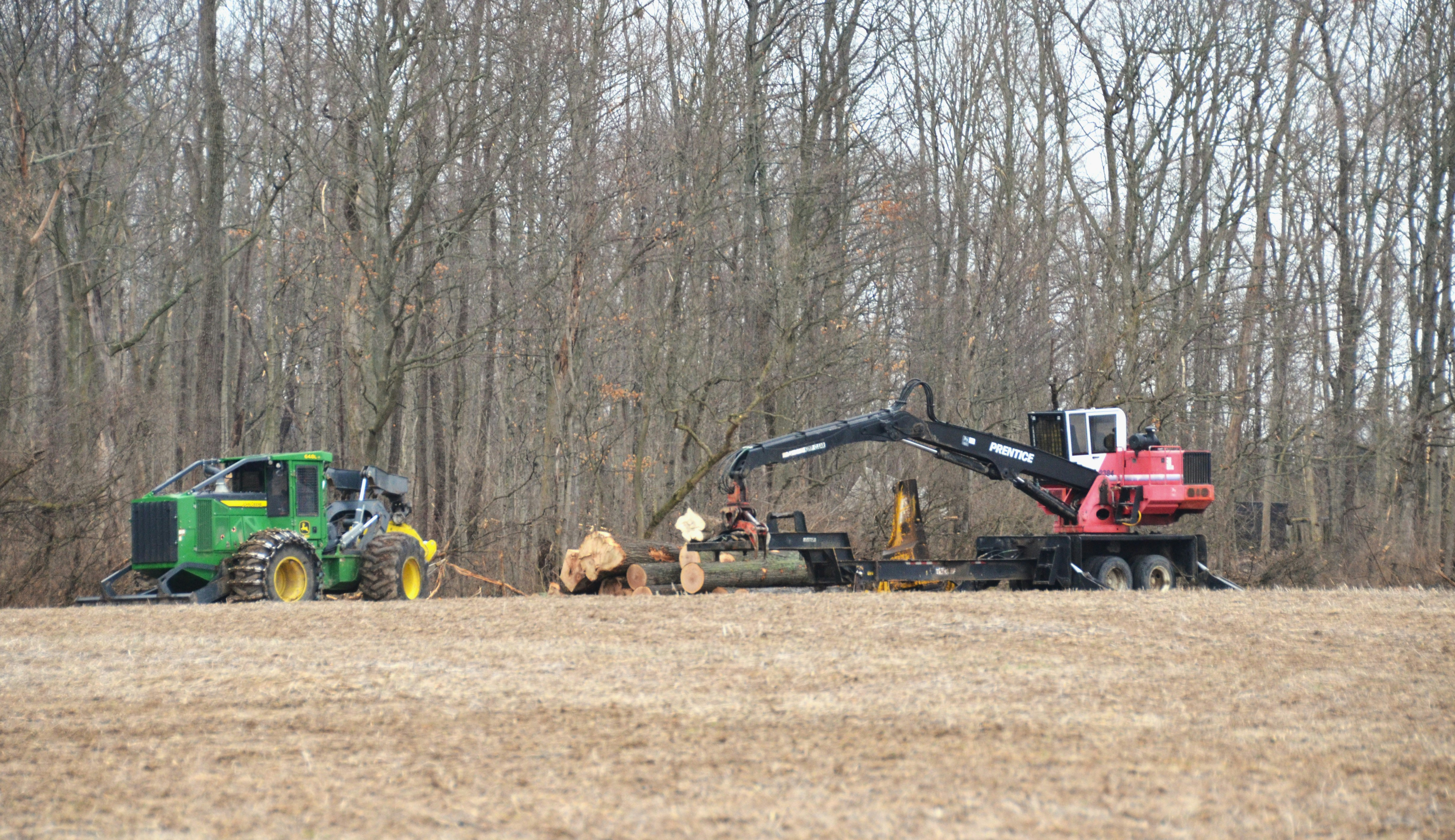 A tractor and a tractor trailer in a field photo – Free Outdoors Image ...
