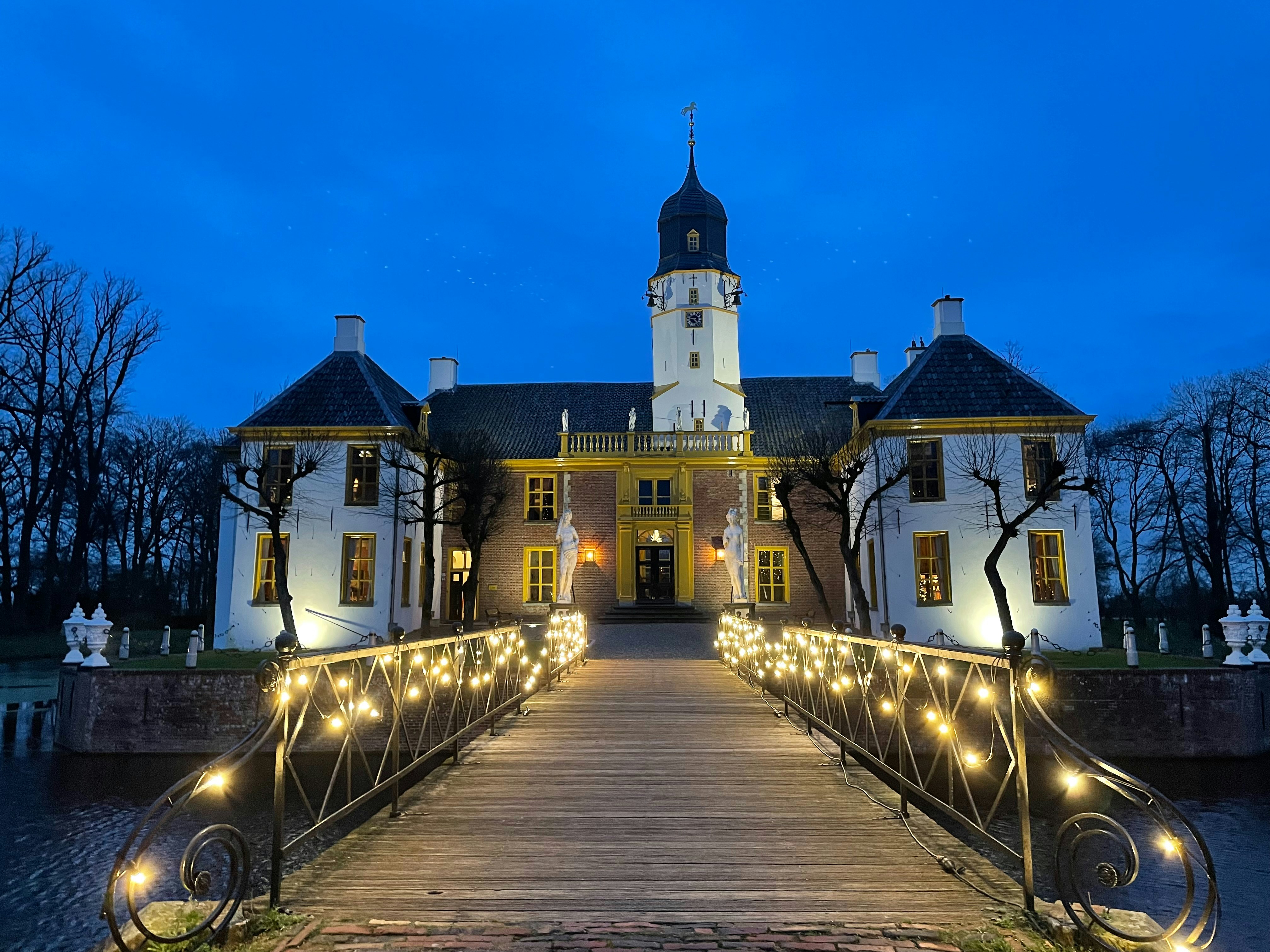 Moonlit Manor: Lantern-Lit Bridge to a Central Clocktower