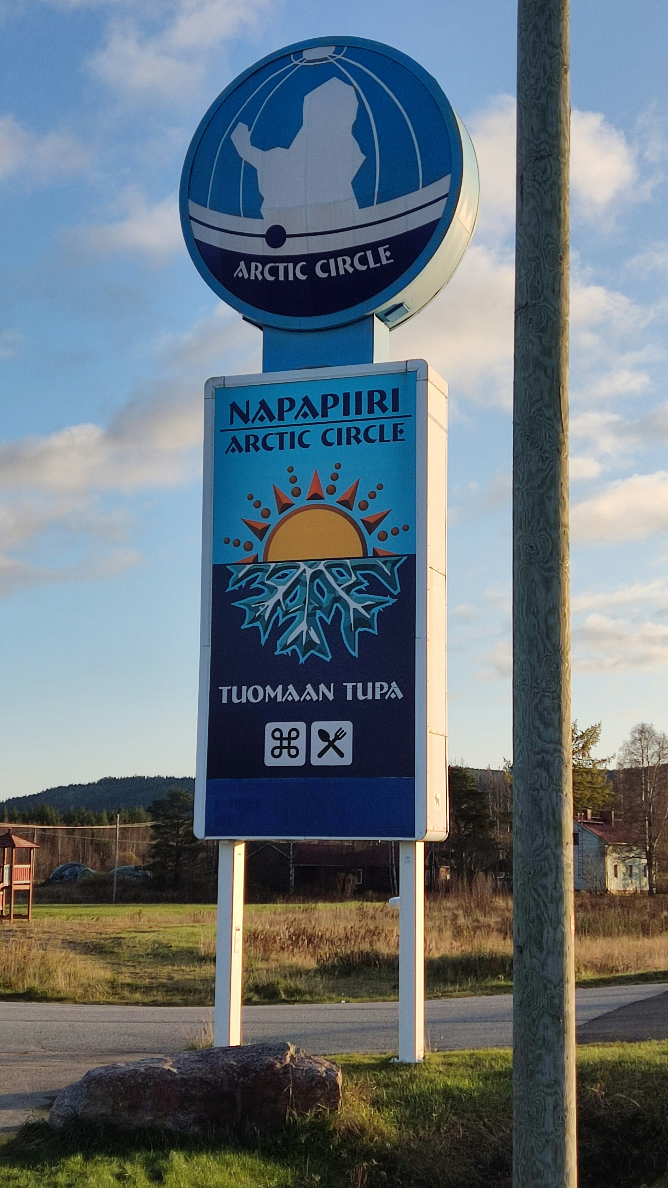 Napapiiri Arctic Circle Sign: A Sunlit Welcome by the Open Road