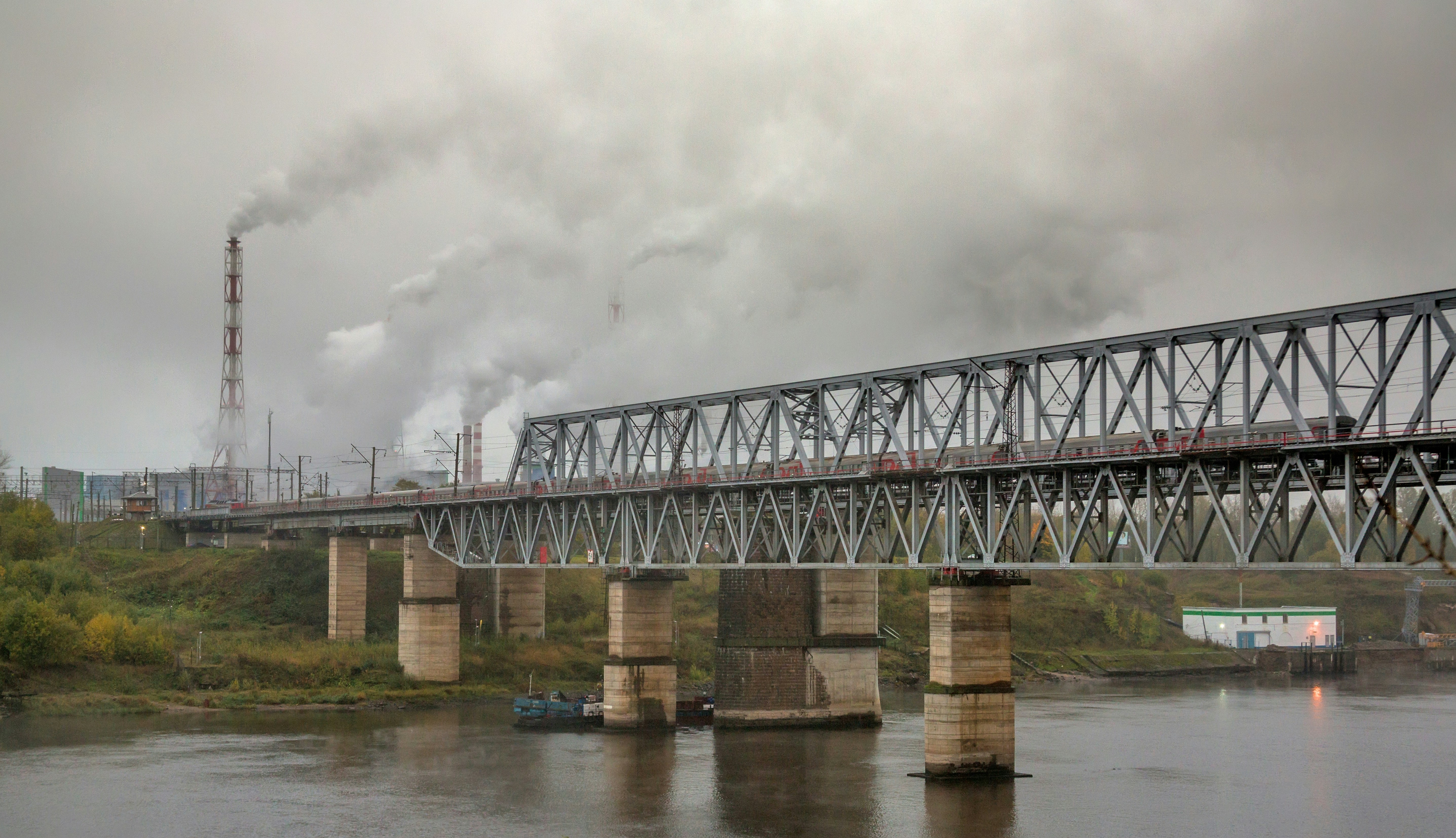 Misty Steel over the River: A Truss Bridge in Industrial Morning Light