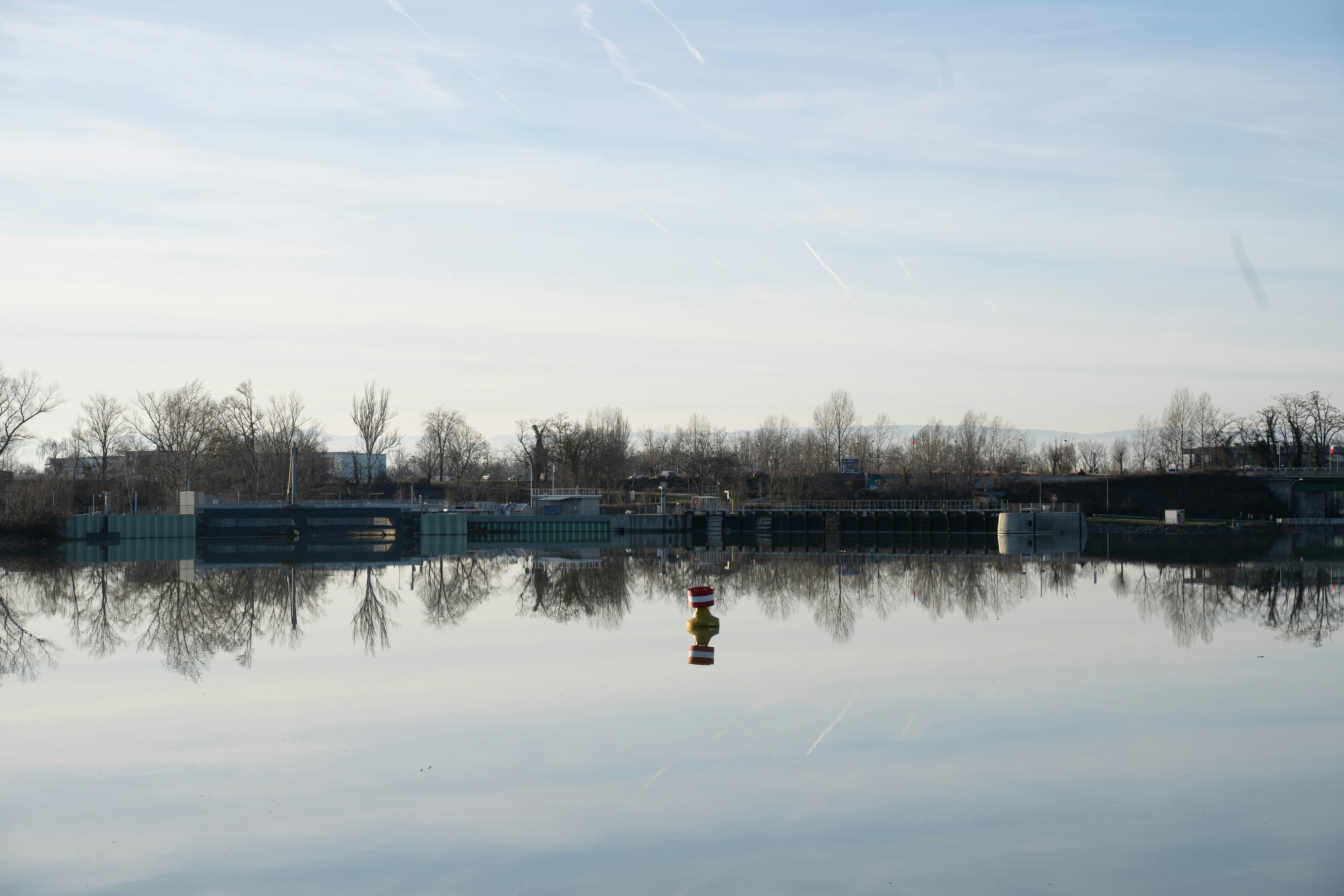 Lone Beacon on a Glassy Lake at Dawn