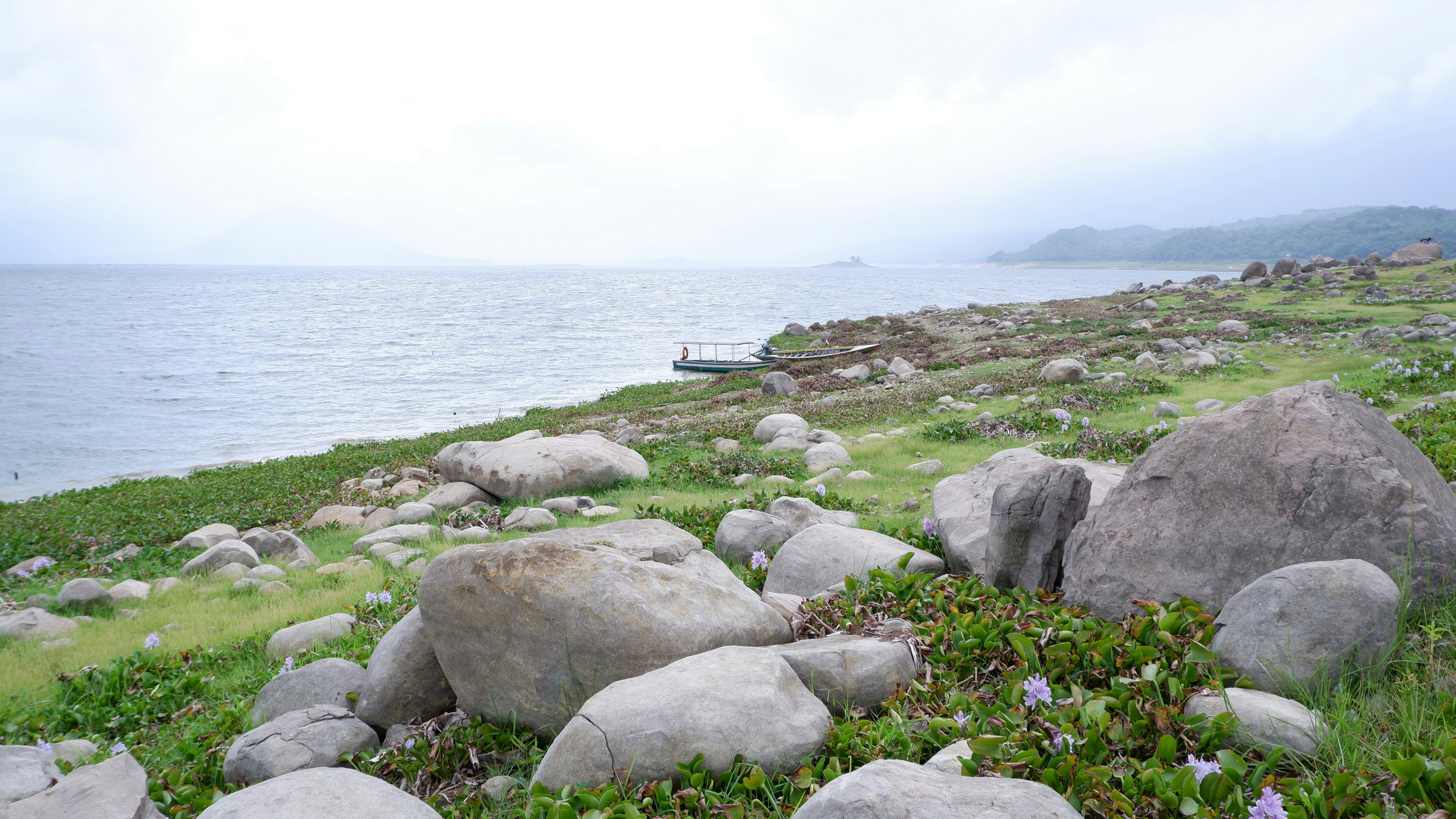 Craggy Shoreline, A Quiet Skiff on the Horizon