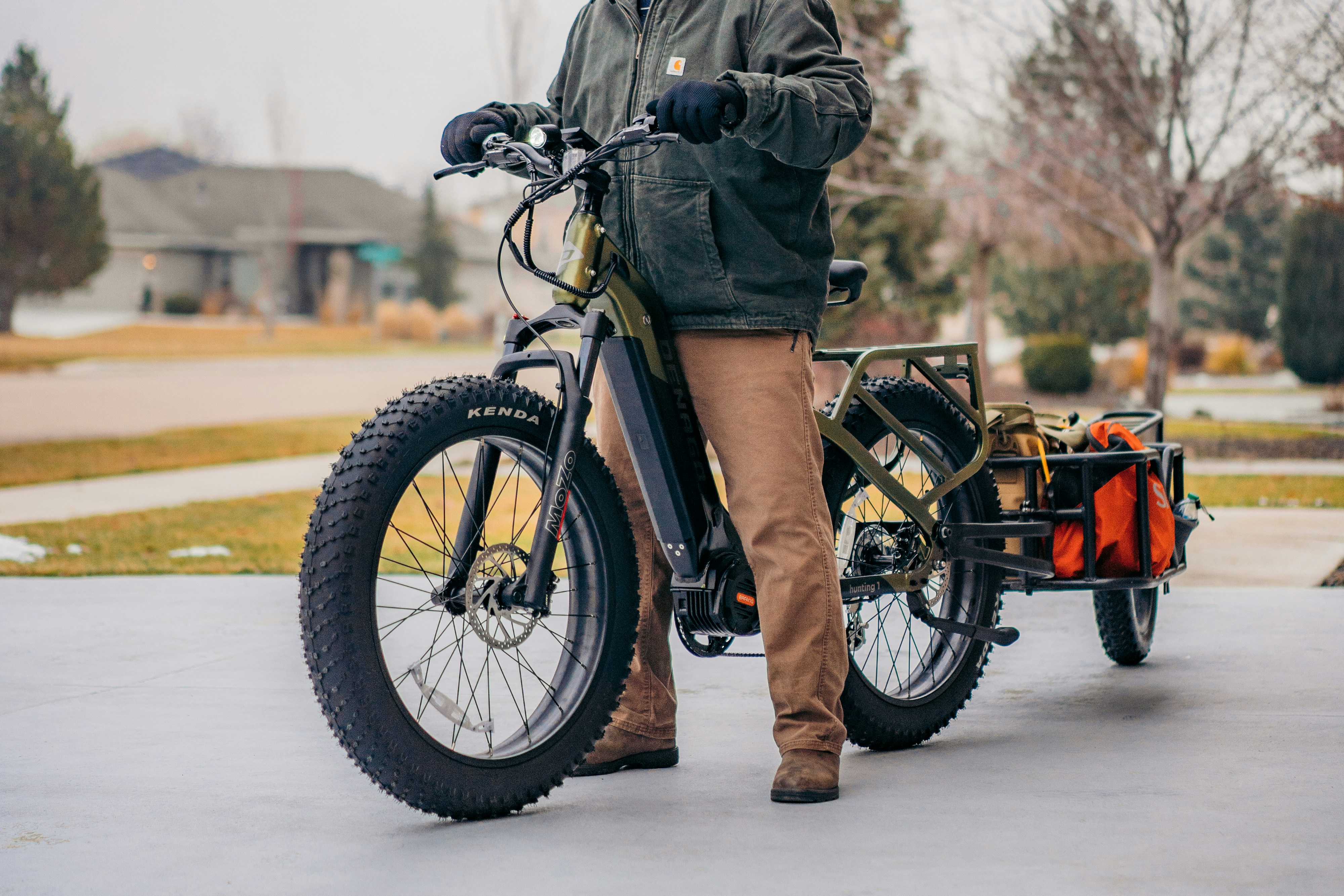 Urban Workhorse: An E-Cargo Bike with a Sturdy Trailer in a Quiet Suburban Driveway