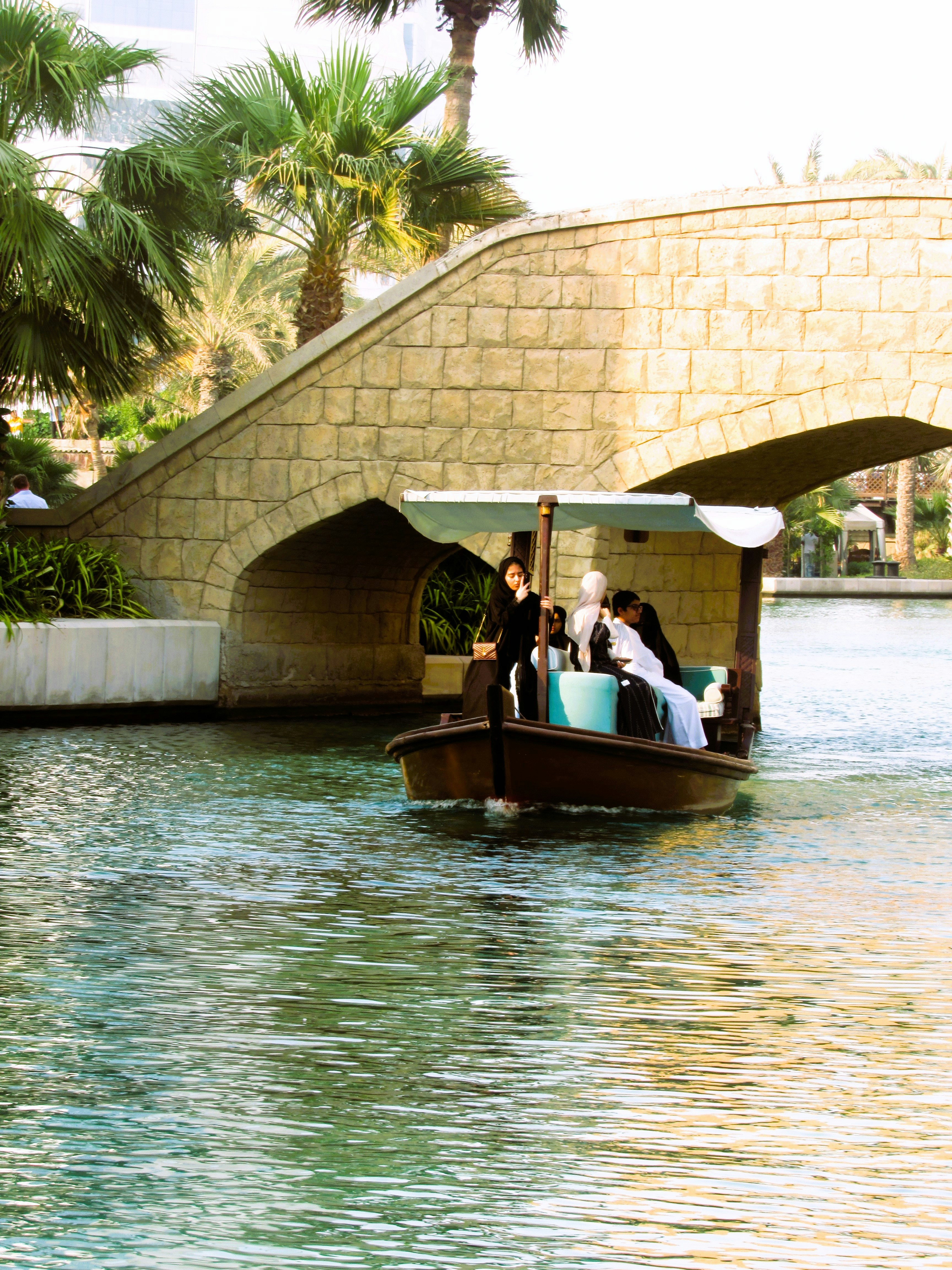 Under the Stone Arch: a Palm-Fringed Boat Ride on a Tranquil Canal