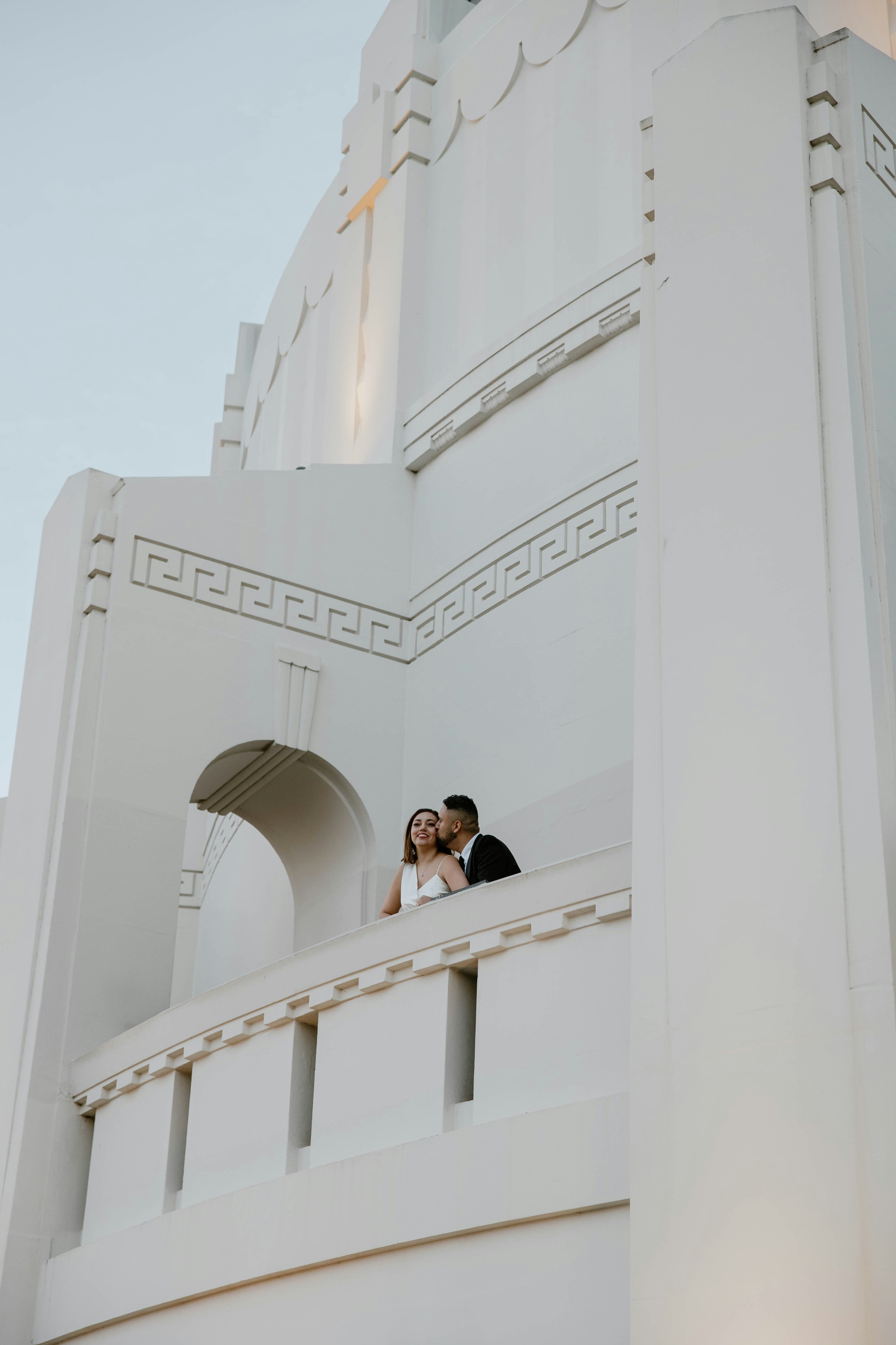 A Quiet Embrace on a White-Scaped Balcony