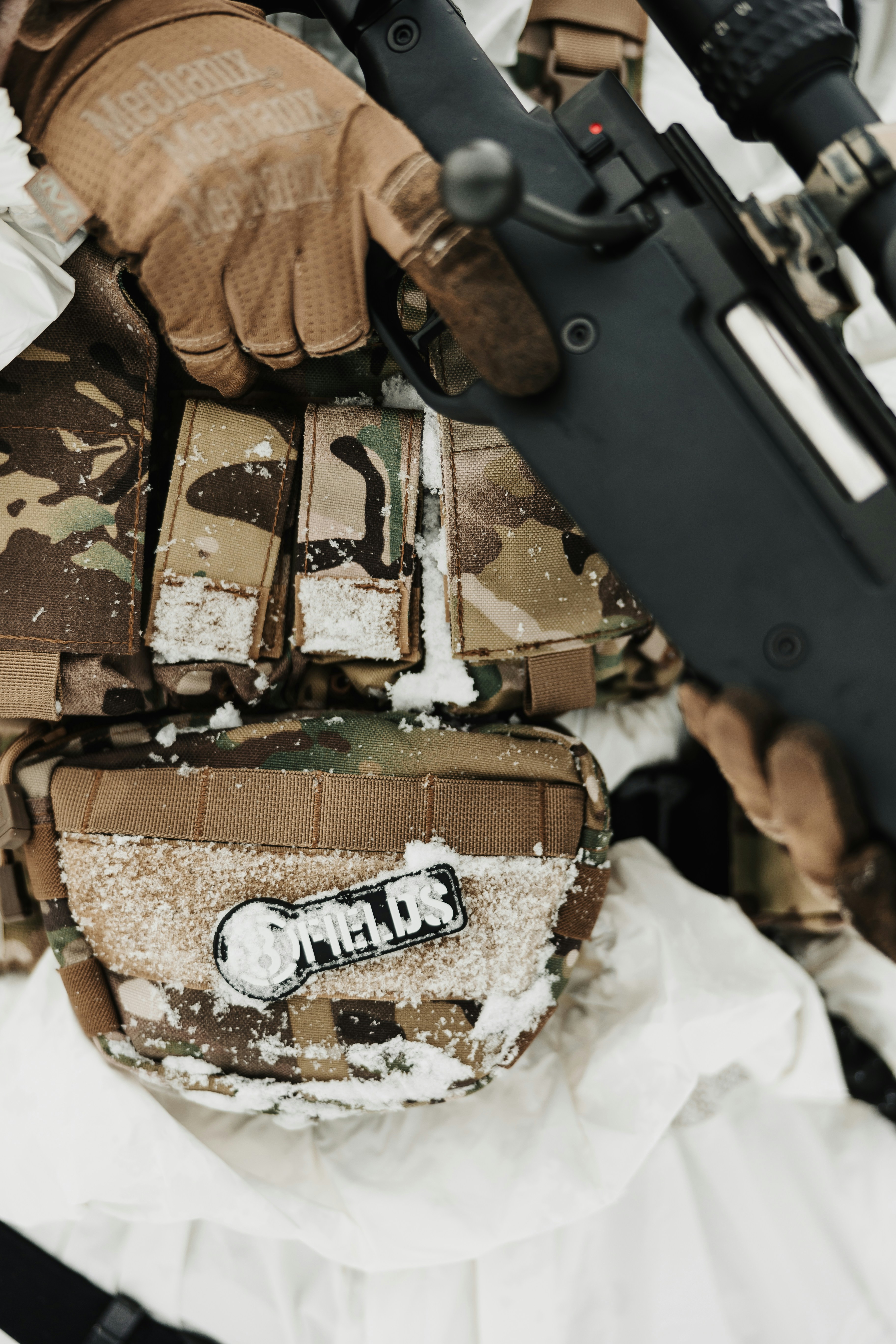 Camouflage Loadout with Snow-Dusted Patch - Close-Up of Tactical Gear and Rifle
